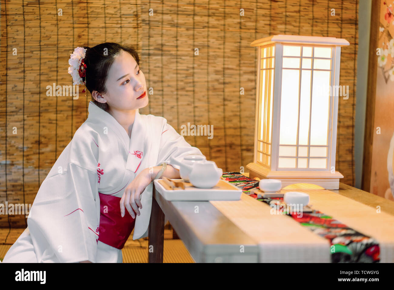 Japanese-style maiden by the tea table Stock Photo - Alamy