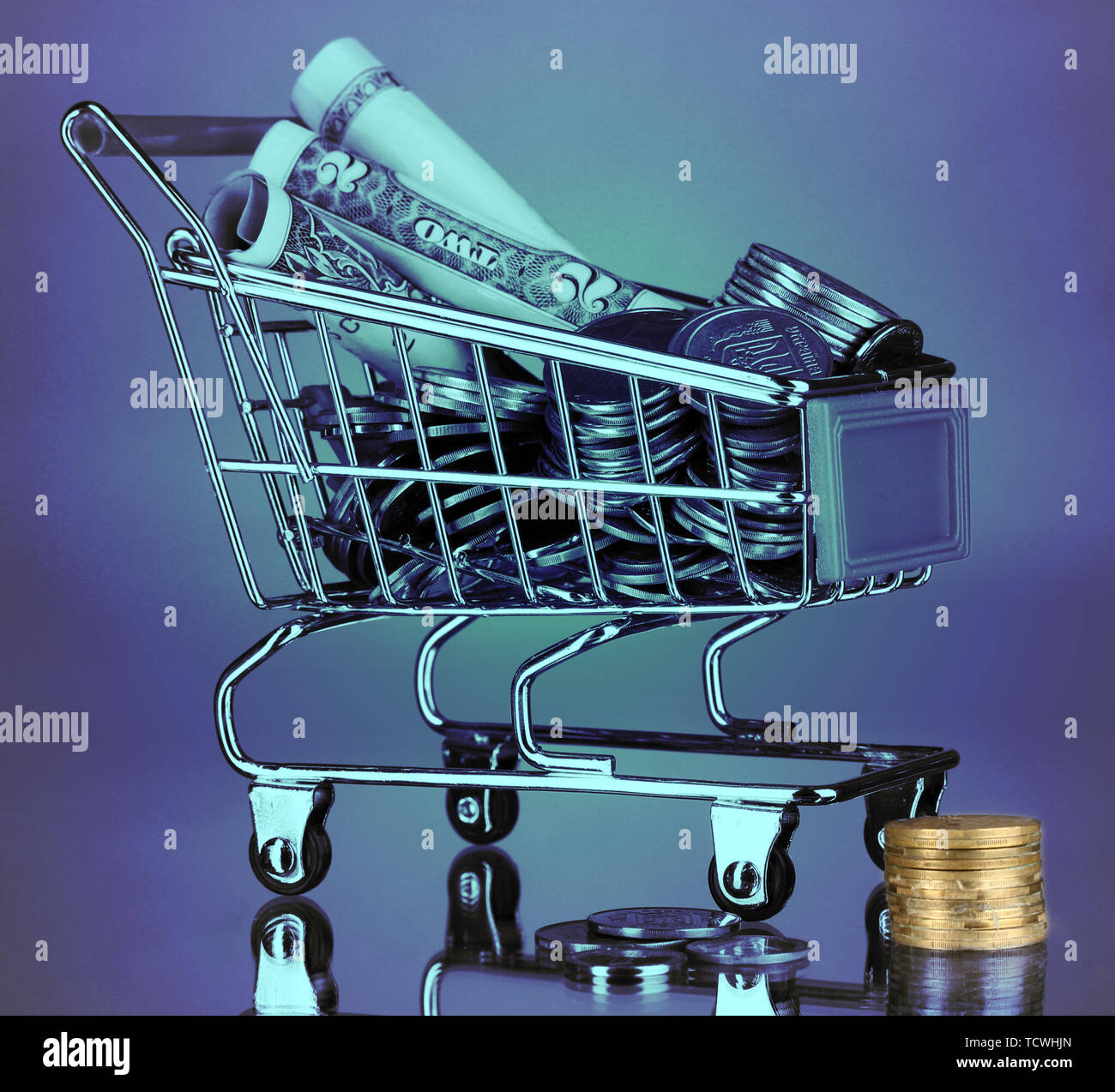 Money in cart in blue light Stock Photo - Alamy