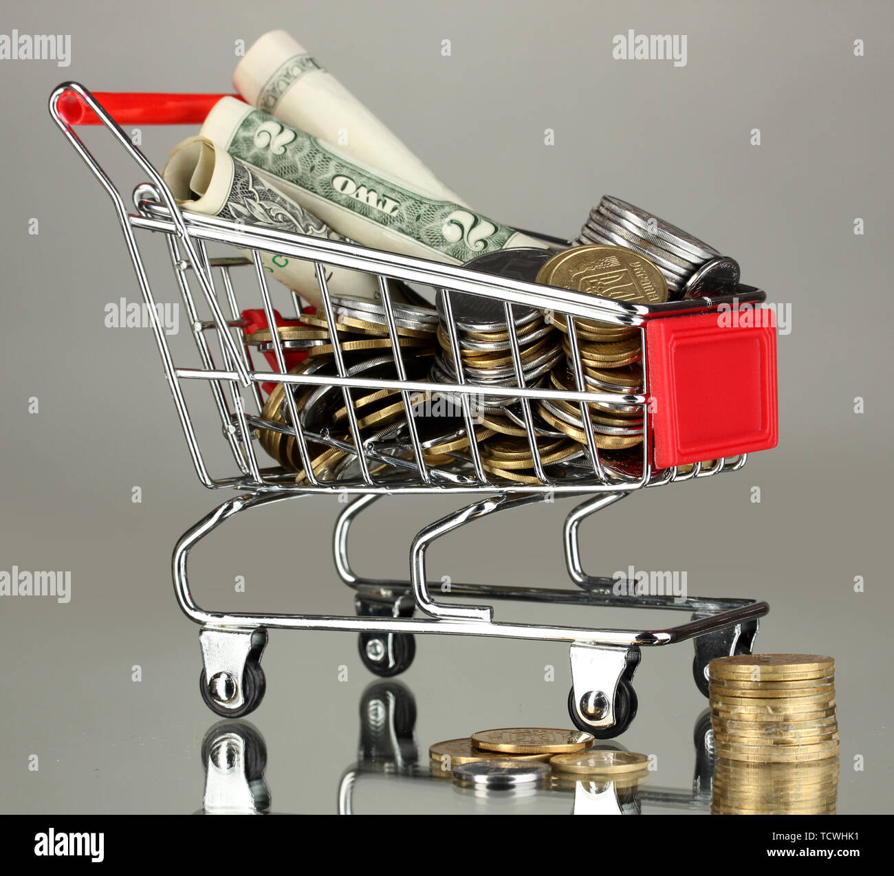 Money in cart on grey background Stock Photo - Alamy