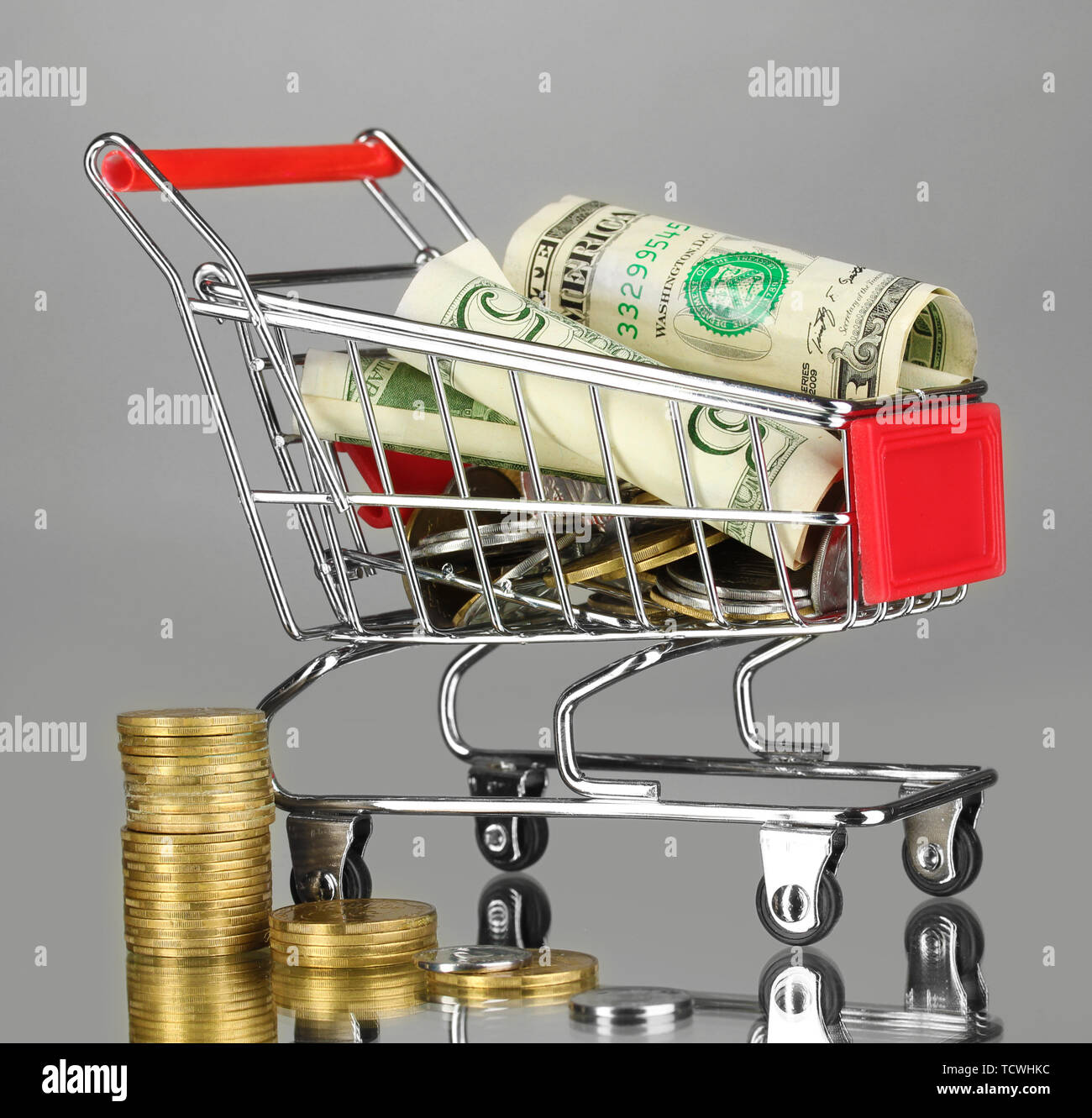 Money in cart on grey background Stock Photo - Alamy