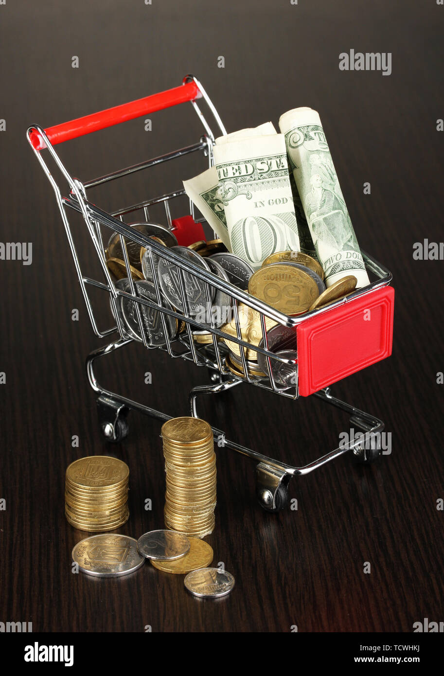 Money in cart isolated on black Stock Photo - Alamy