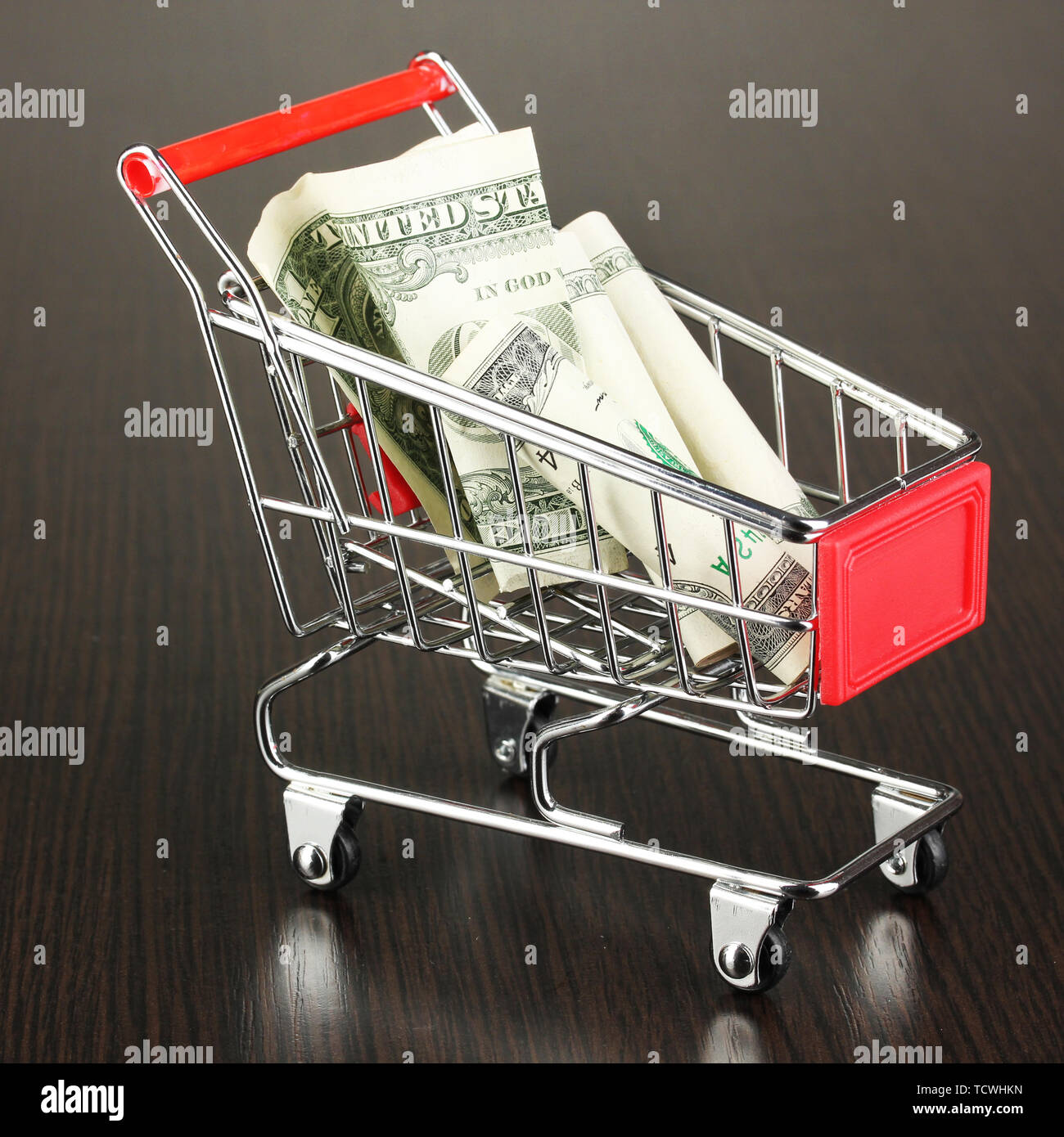 Money in cart isolated on black Stock Photo - Alamy