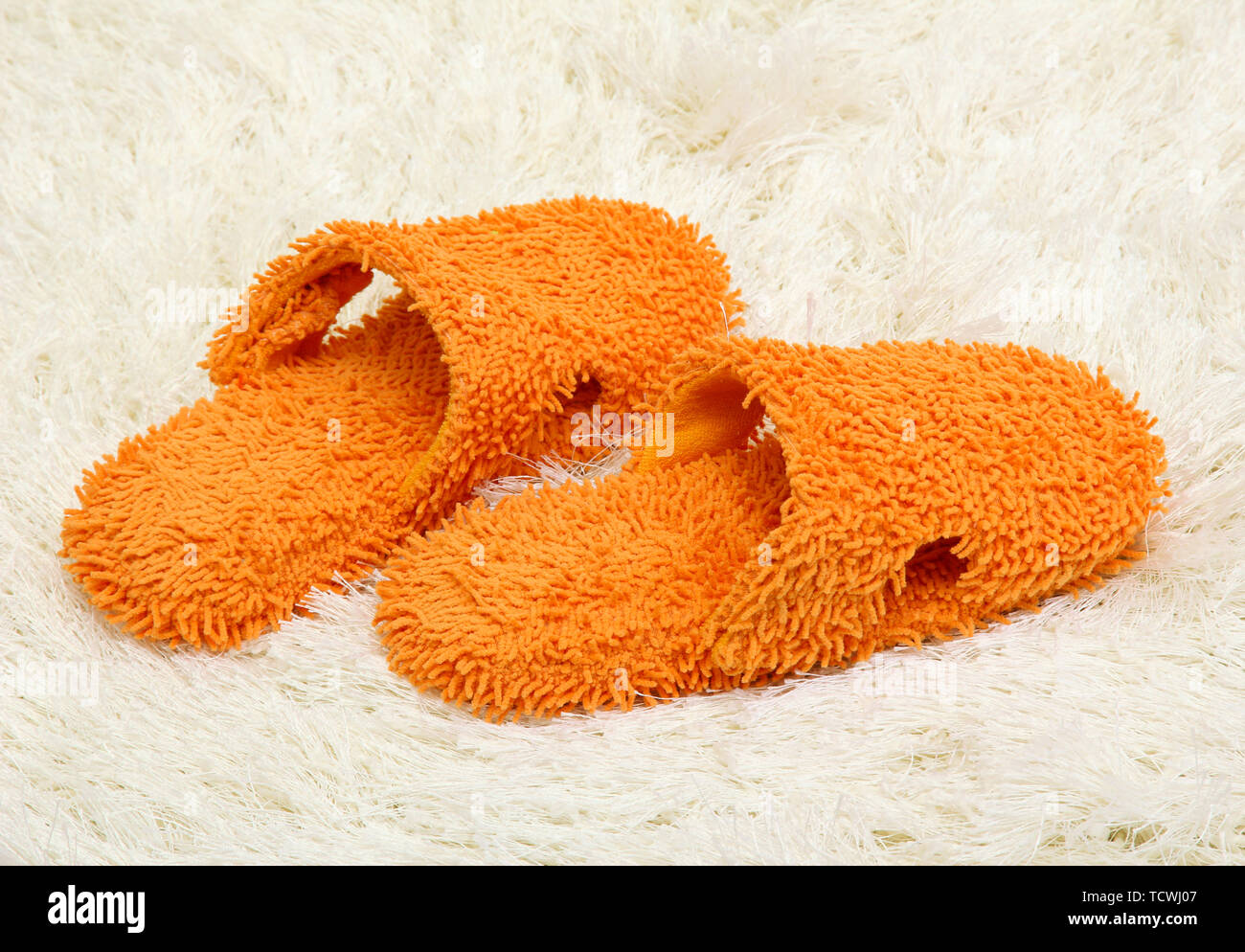 bright slippers, on carpet background Stock Photo - Alamy