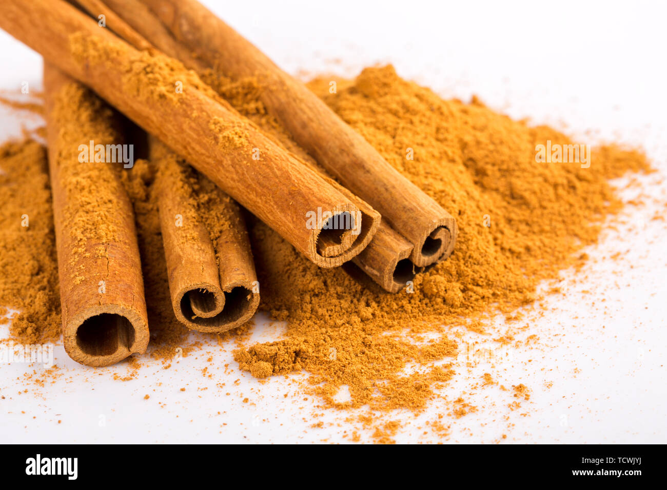 Cinnamon and cinnamon powder on white background Stock Photo - Alamy