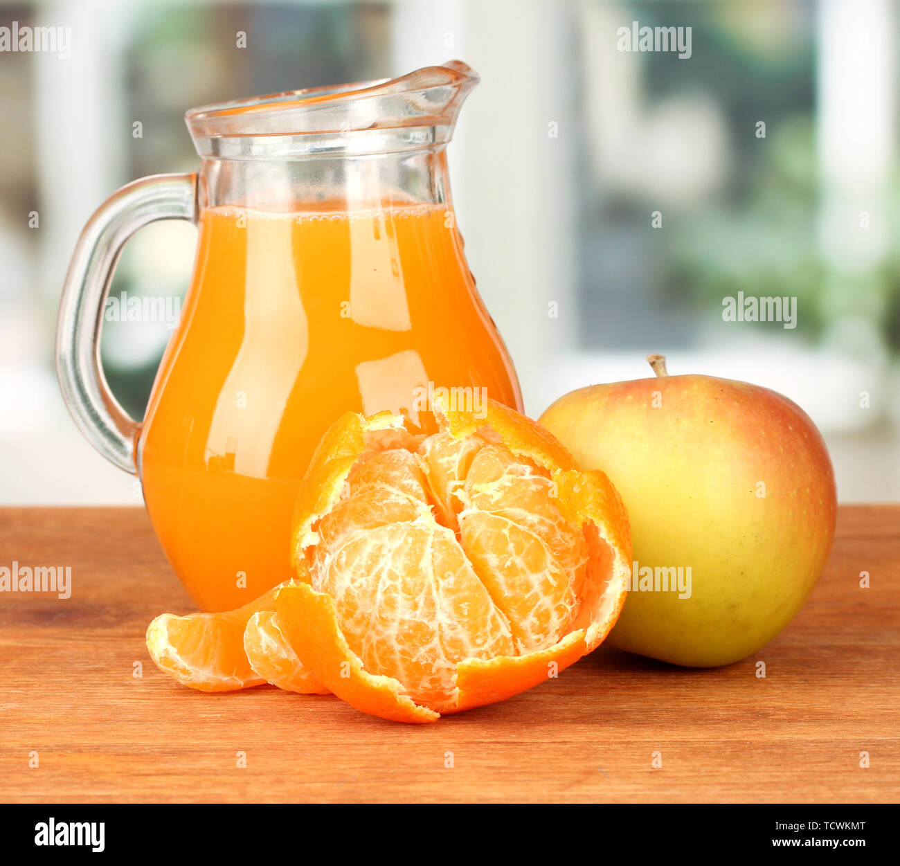 Full jug of multivitamin juice on bright background Stock Photo - Alamy