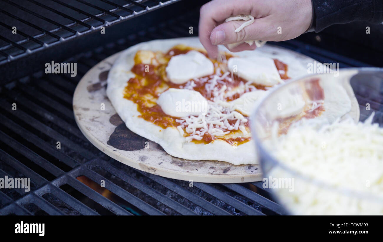 Cooking pizza on outdoor gas grill Stock Photo - Alamy