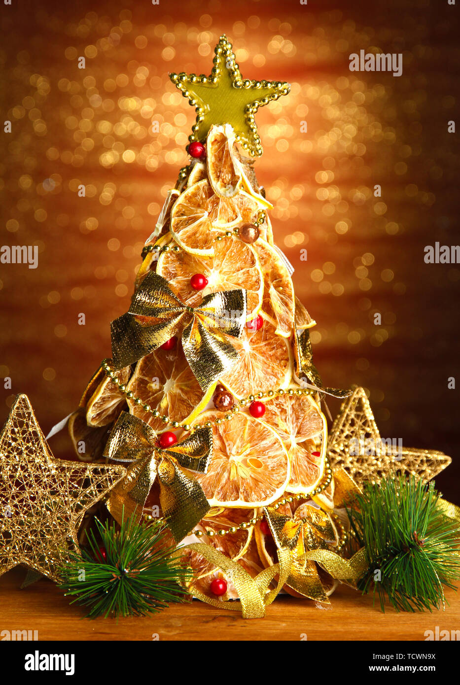 beautiful christmas tree of dry lemons with decor, on shine background ...