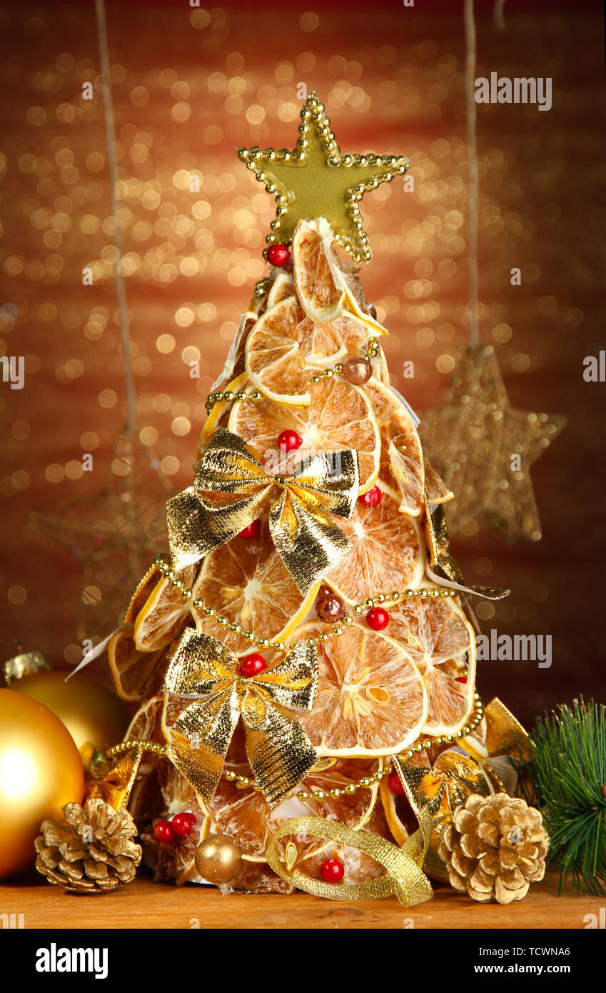 beautiful christmas tree of dry lemons with decor, on shine background ...