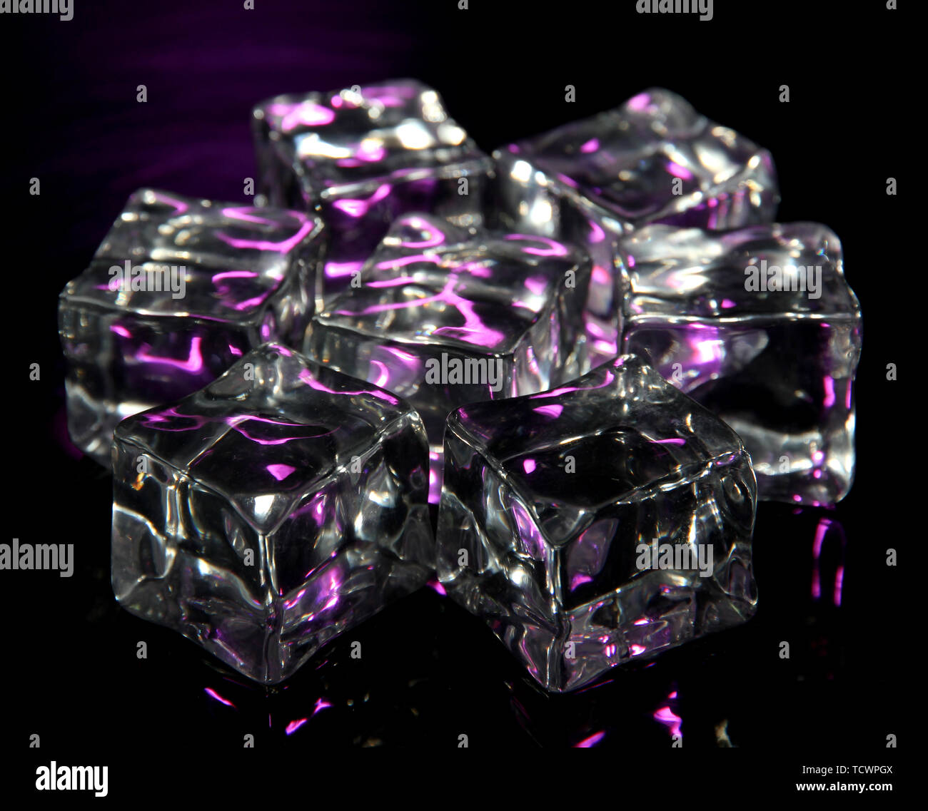 Ice cubes on dark purple background Stock Photo - Alamy