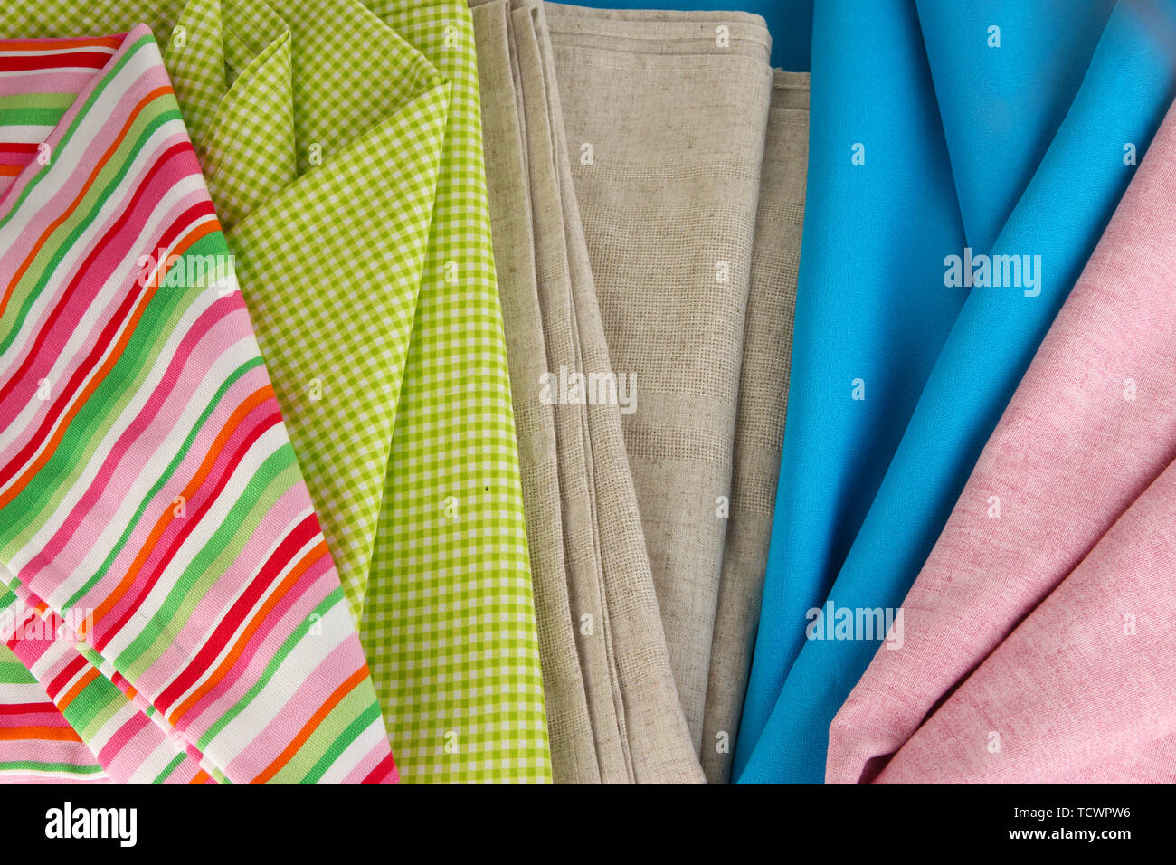 Pile of different fabrics close-up background Stock Photo - Alamy
