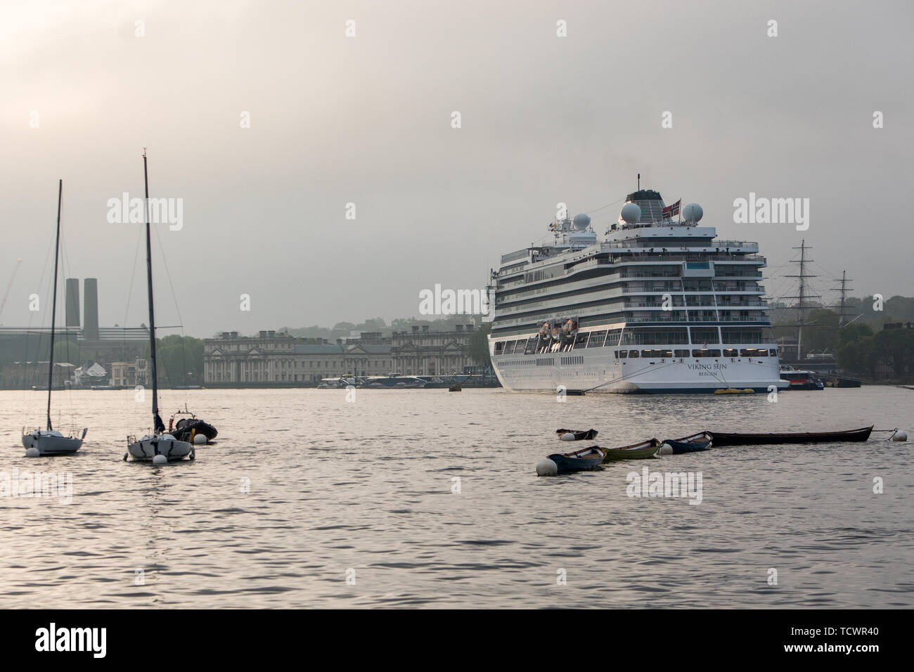 Cruise ship Viking Sun dwarfs the Cutty Sark and the historic buildings ...