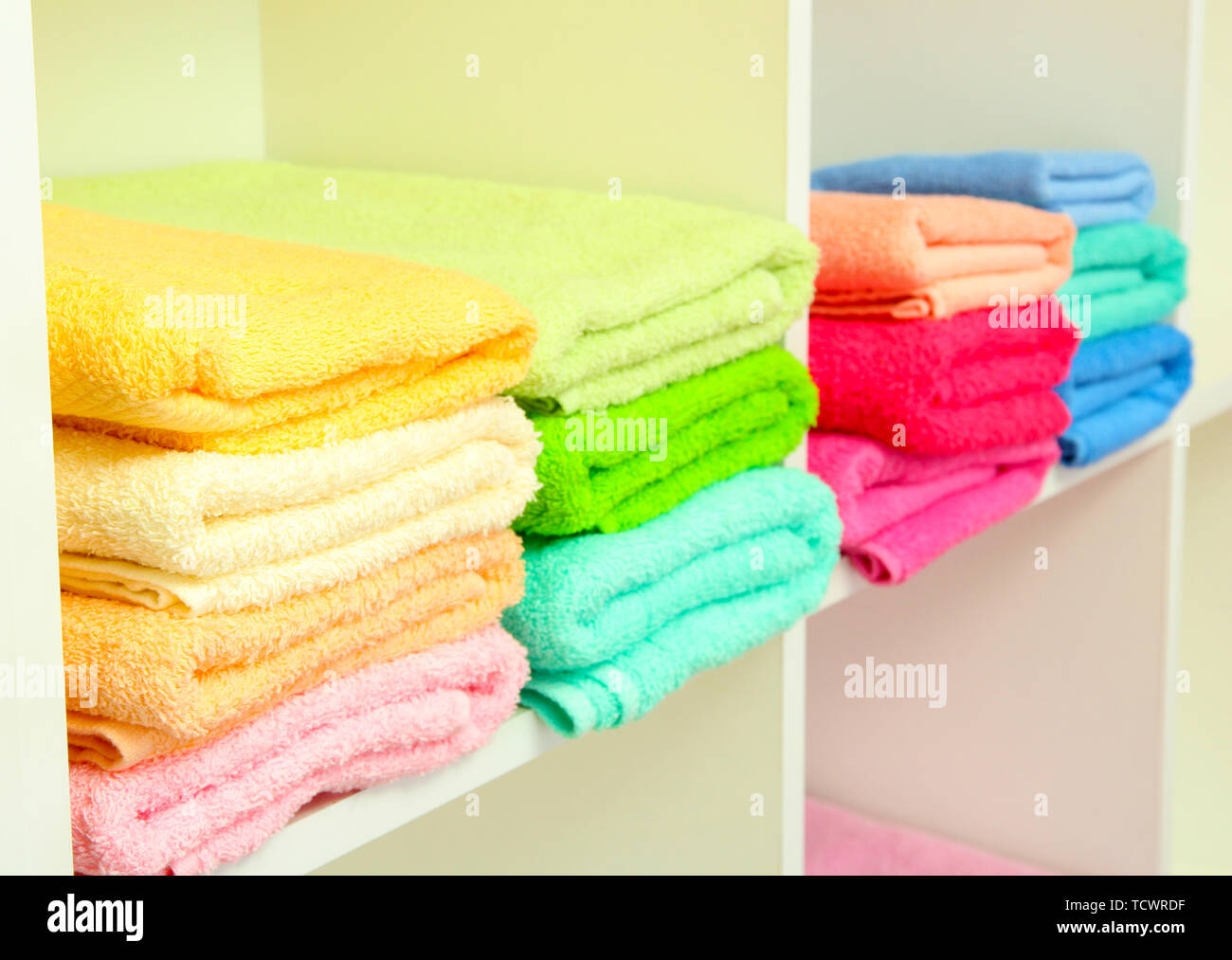 colorful towels on shelves in bathroom Stock Photo - Alamy