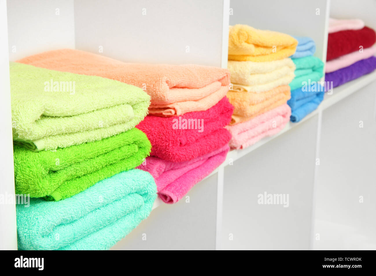 colorful towels on shelves in bathroom Stock Photo - Alamy
