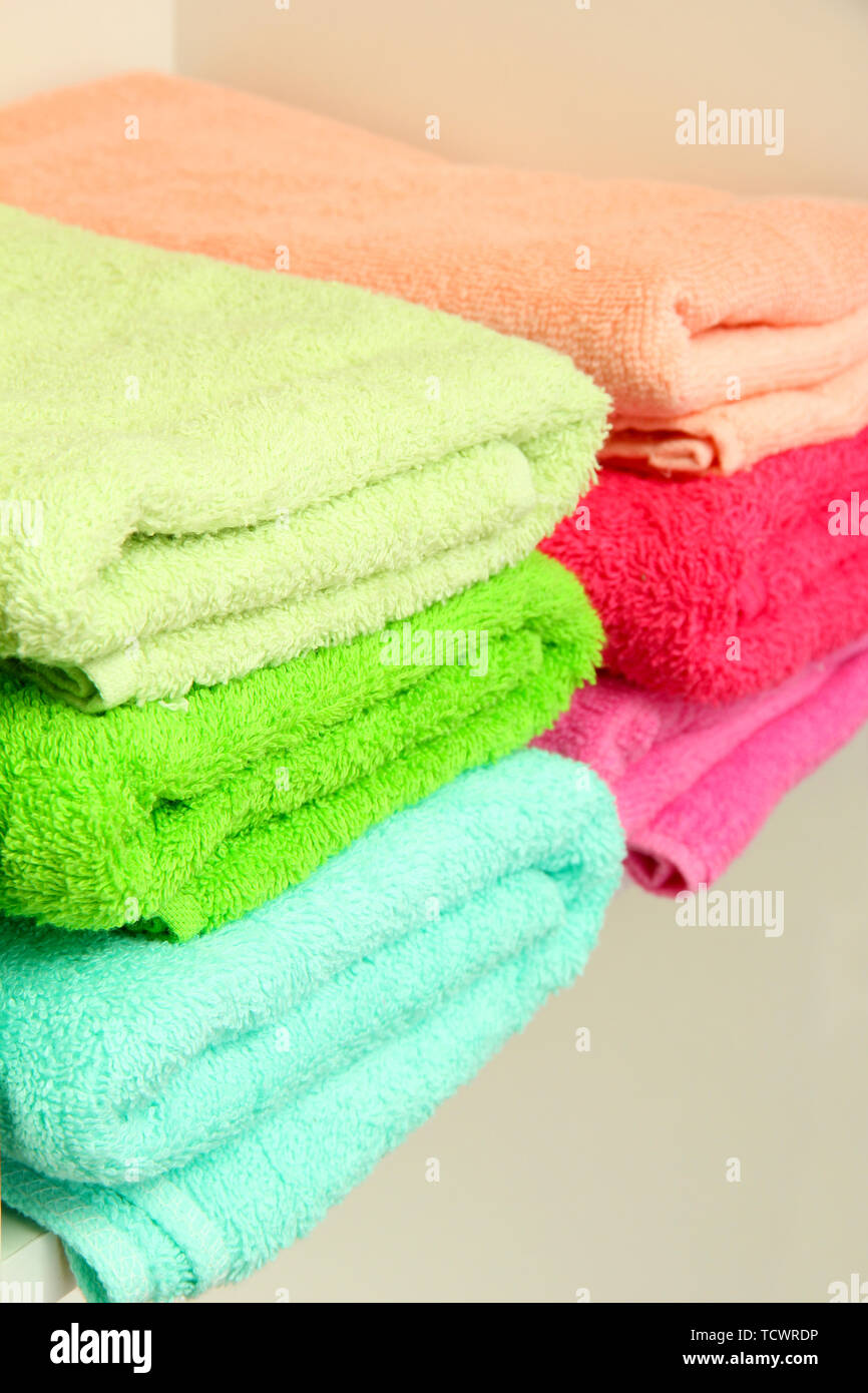 colorful towels on shelves in bathroom Stock Photo - Alamy