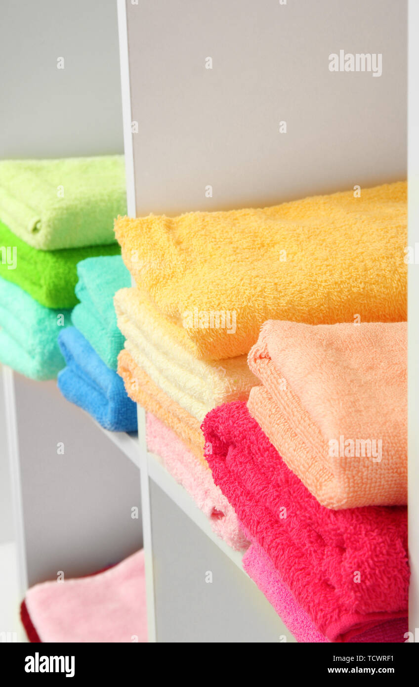 colorful towels on shelves in bathroom Stock Photo - Alamy