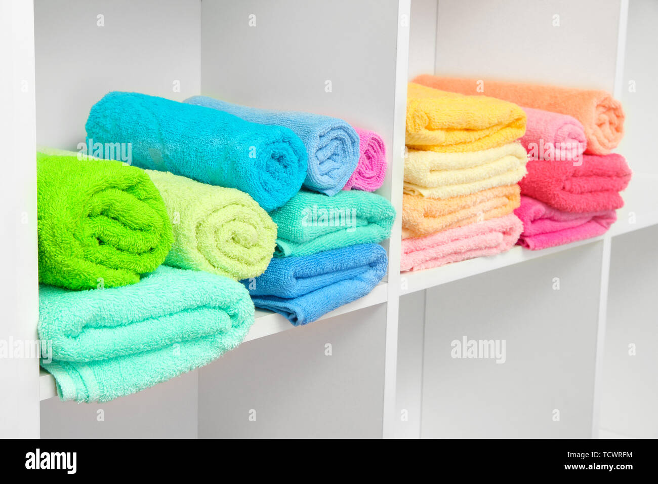 colorful towels on shelves in bathroom Stock Photo - Alamy