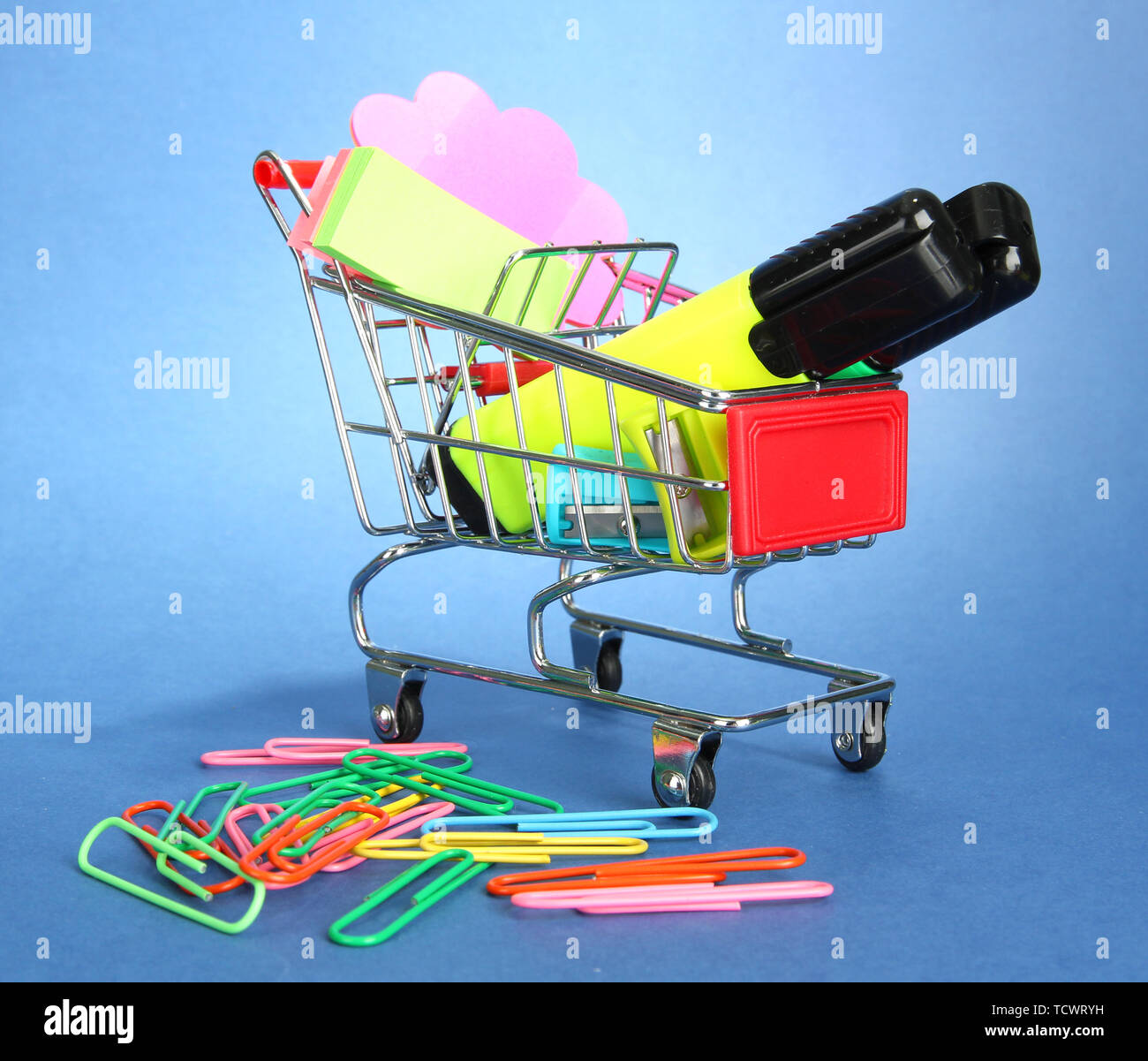 trolley with school equipment on blue background Stock Photo - Alamy
