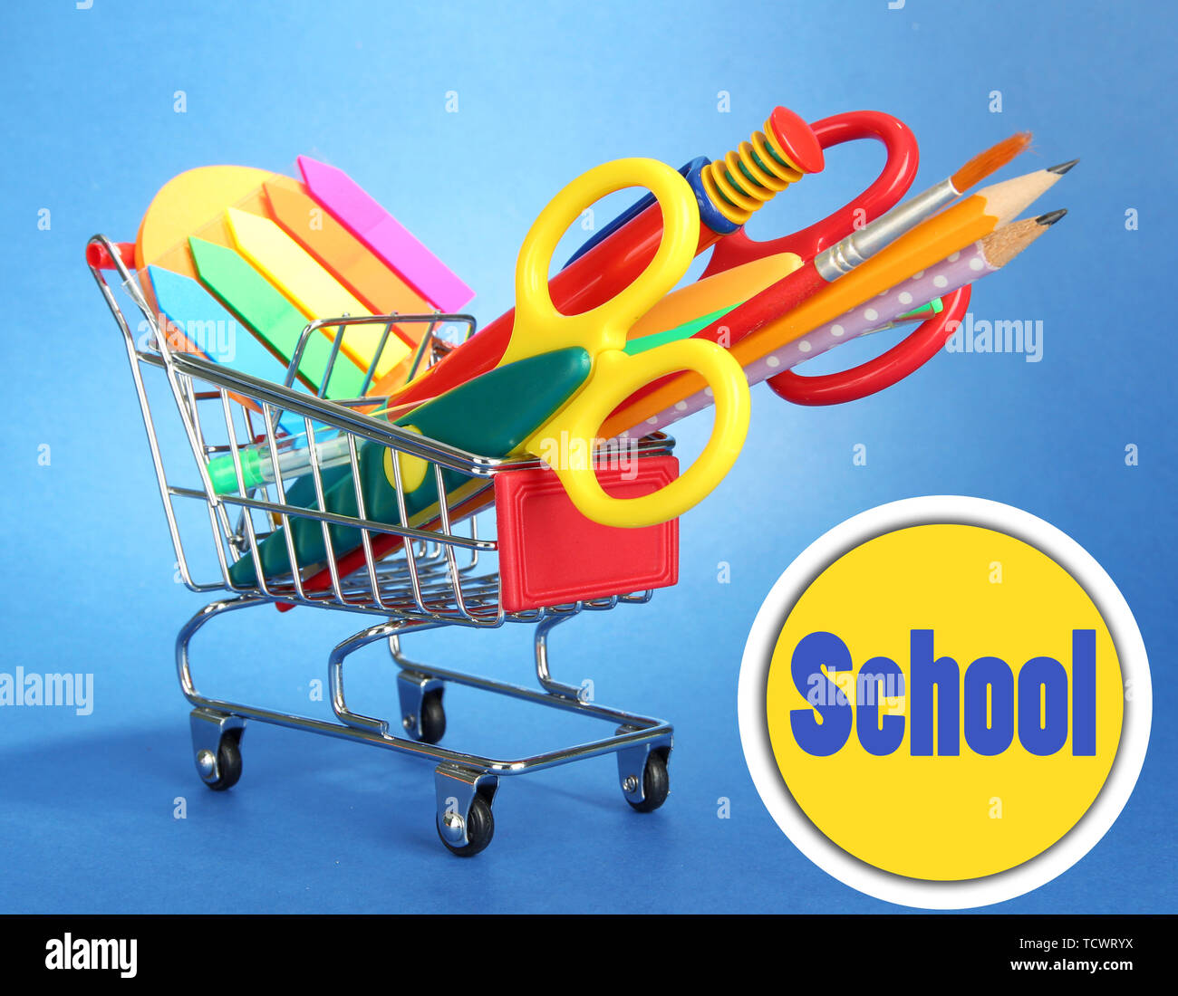 trolley with school equipment on blue background Stock Photo - Alamy
