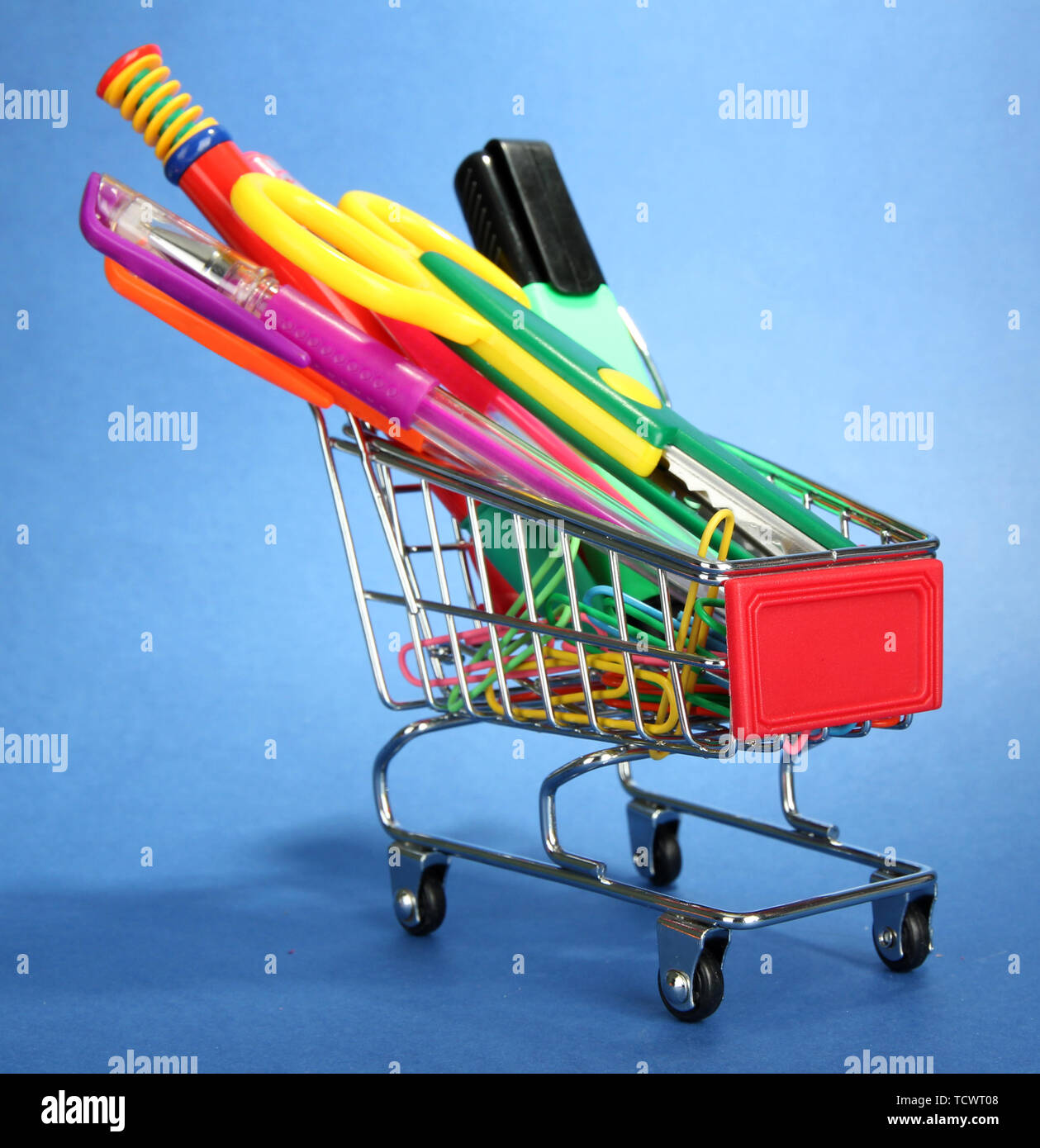 trolley with school equipment on blue background Stock Photo - Alamy