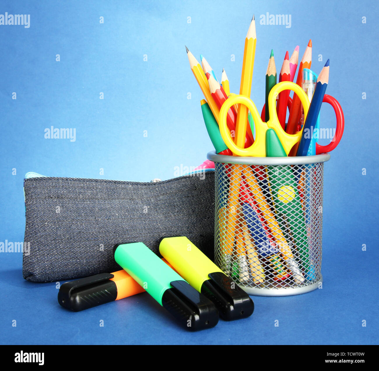 pencil box with school equipment on blue background Stock Photo - Alamy
