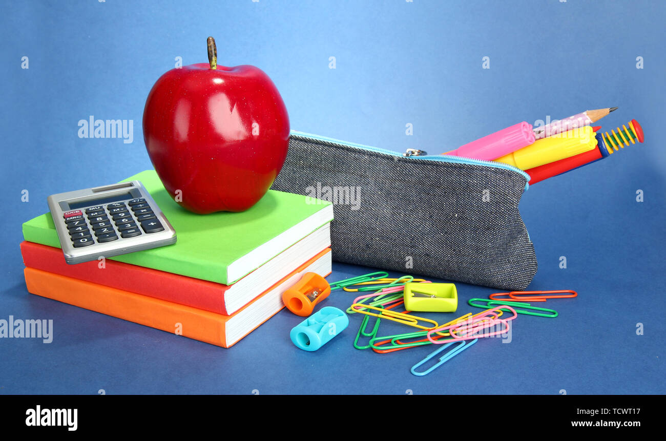 pencil box with school equipment on blue background Stock Photo - Alamy