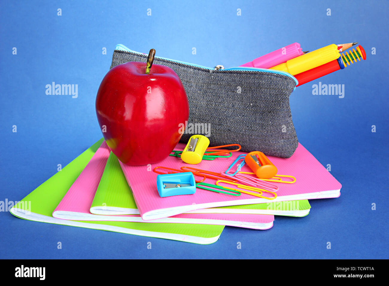 pencil box with school equipment on blue background Stock Photo - Alamy