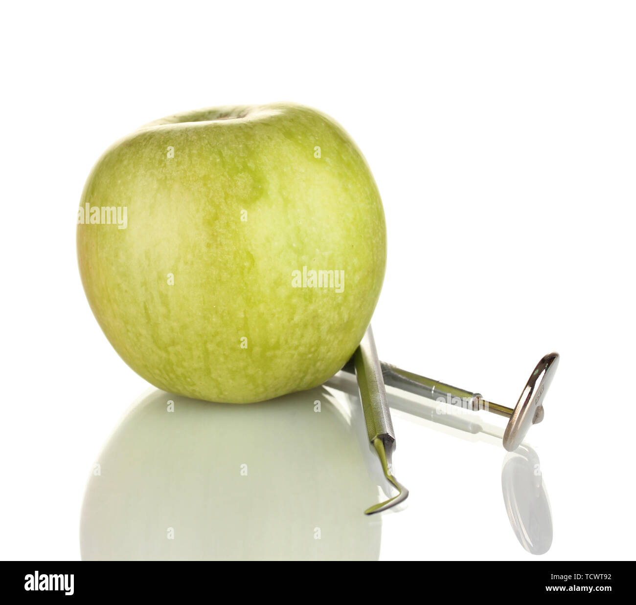 Green apple and dental tools isolated on white Stock Photo - Alamy