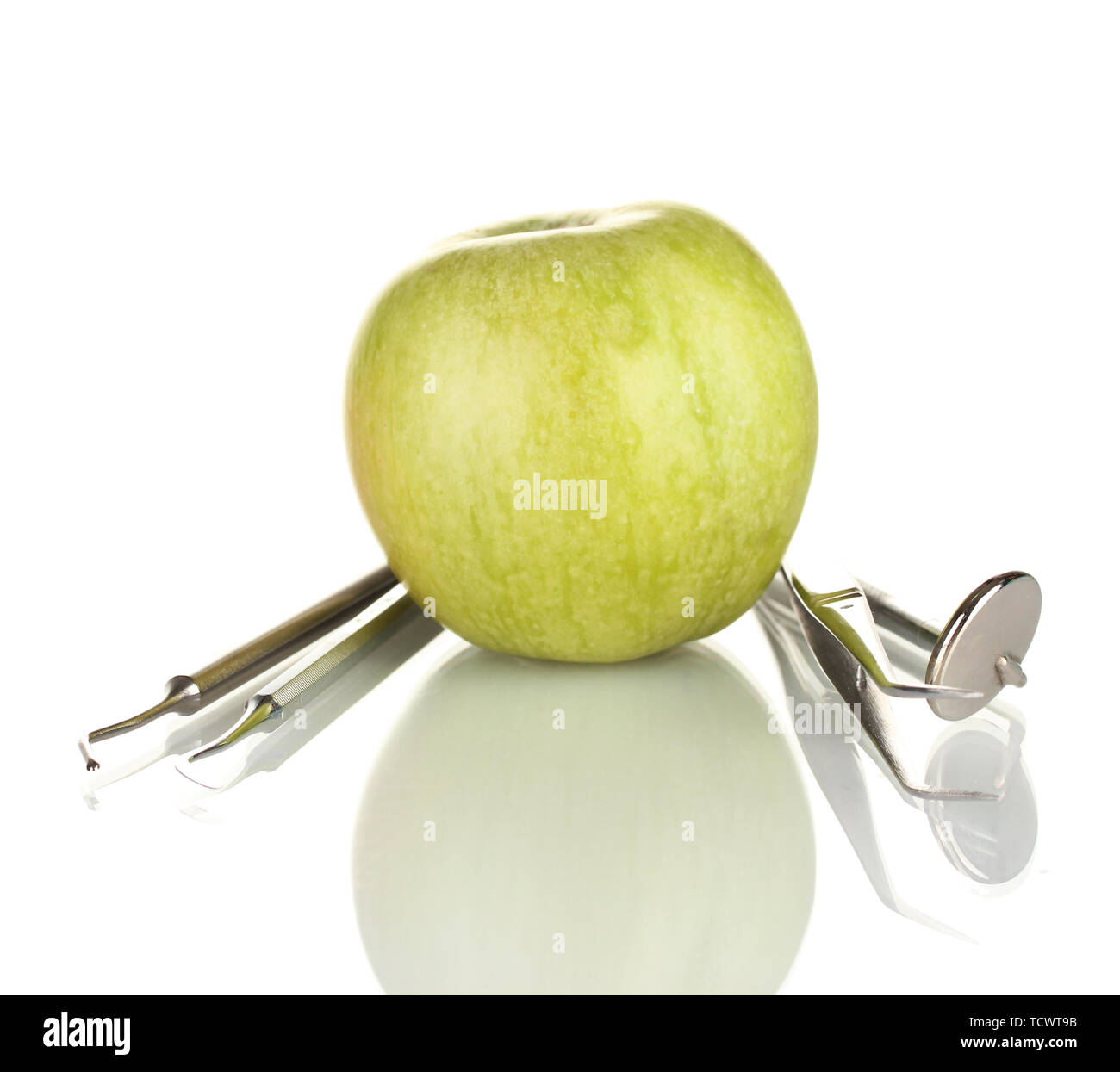 Green apple and dental tools isolated on white Stock Photo - Alamy