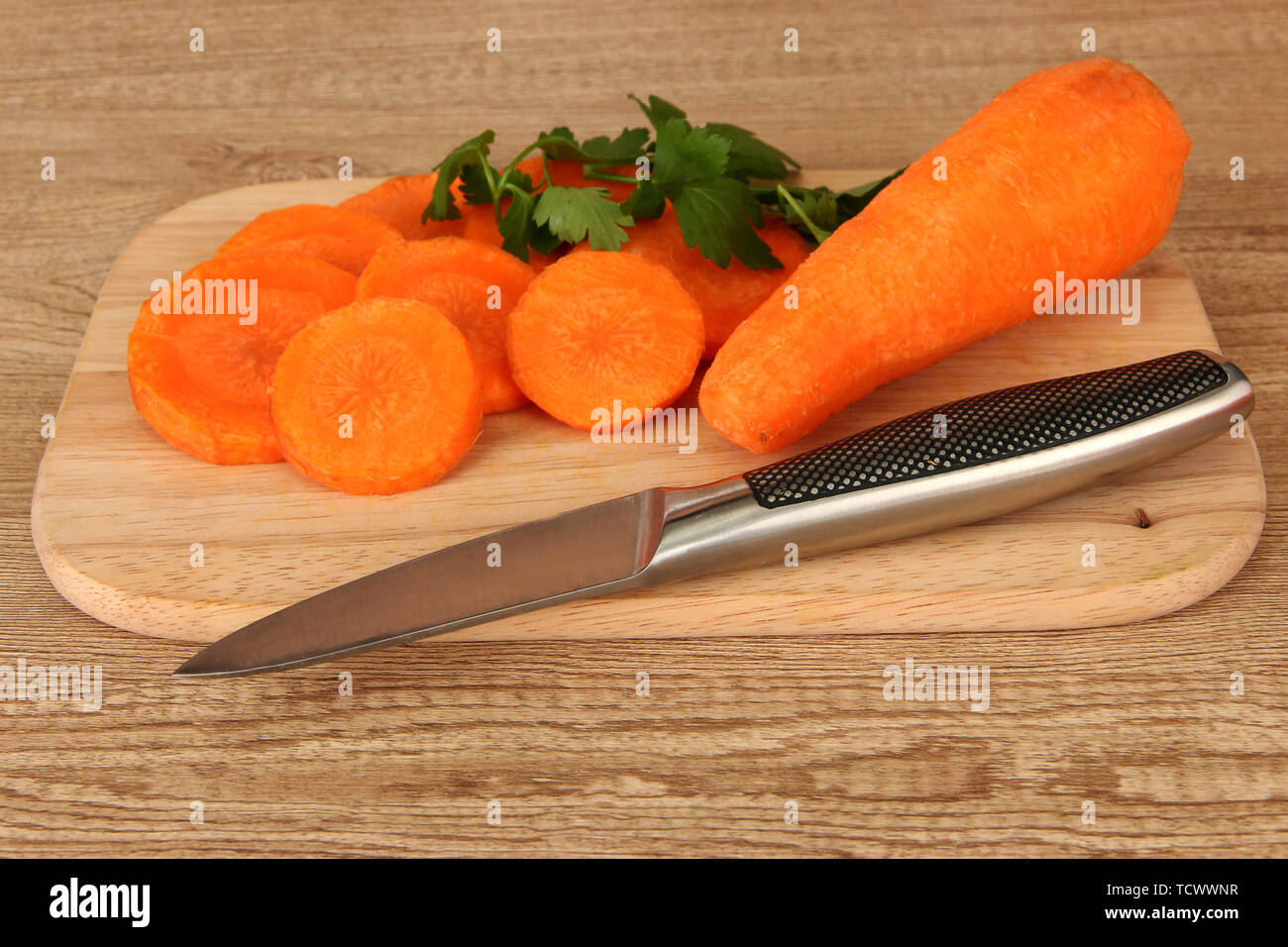carrots with knife on cutting board on table in kitchen Stock Photo - Alamy