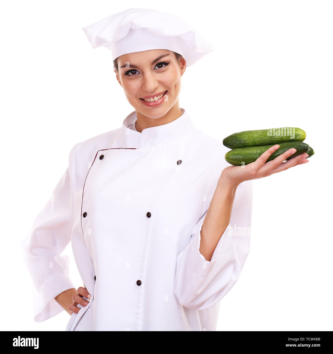 Portrait of young woman chef with vegetables isolated on white Stock ...