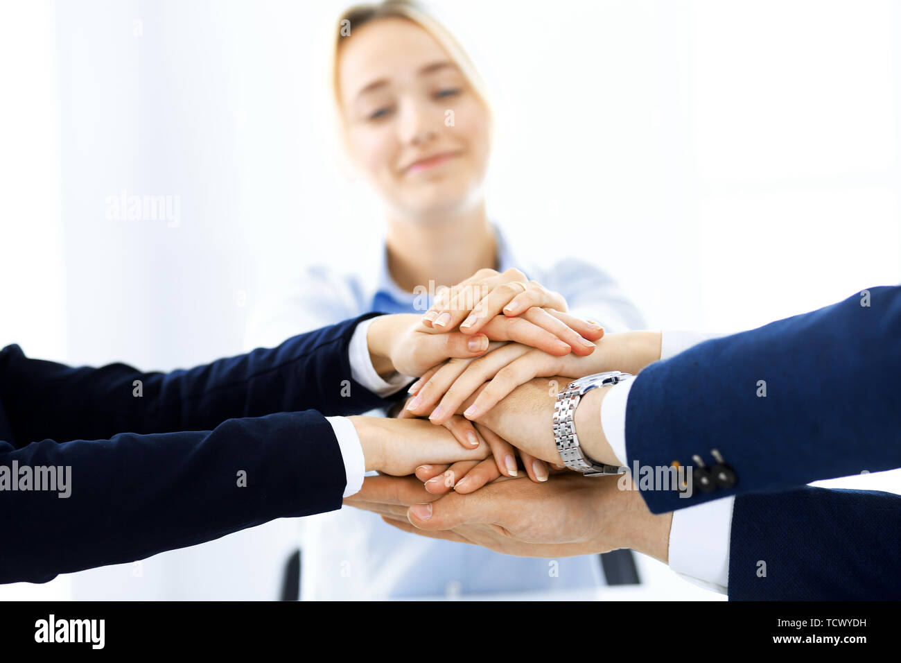 Business team showing unity with their hands together. Group of people ...
