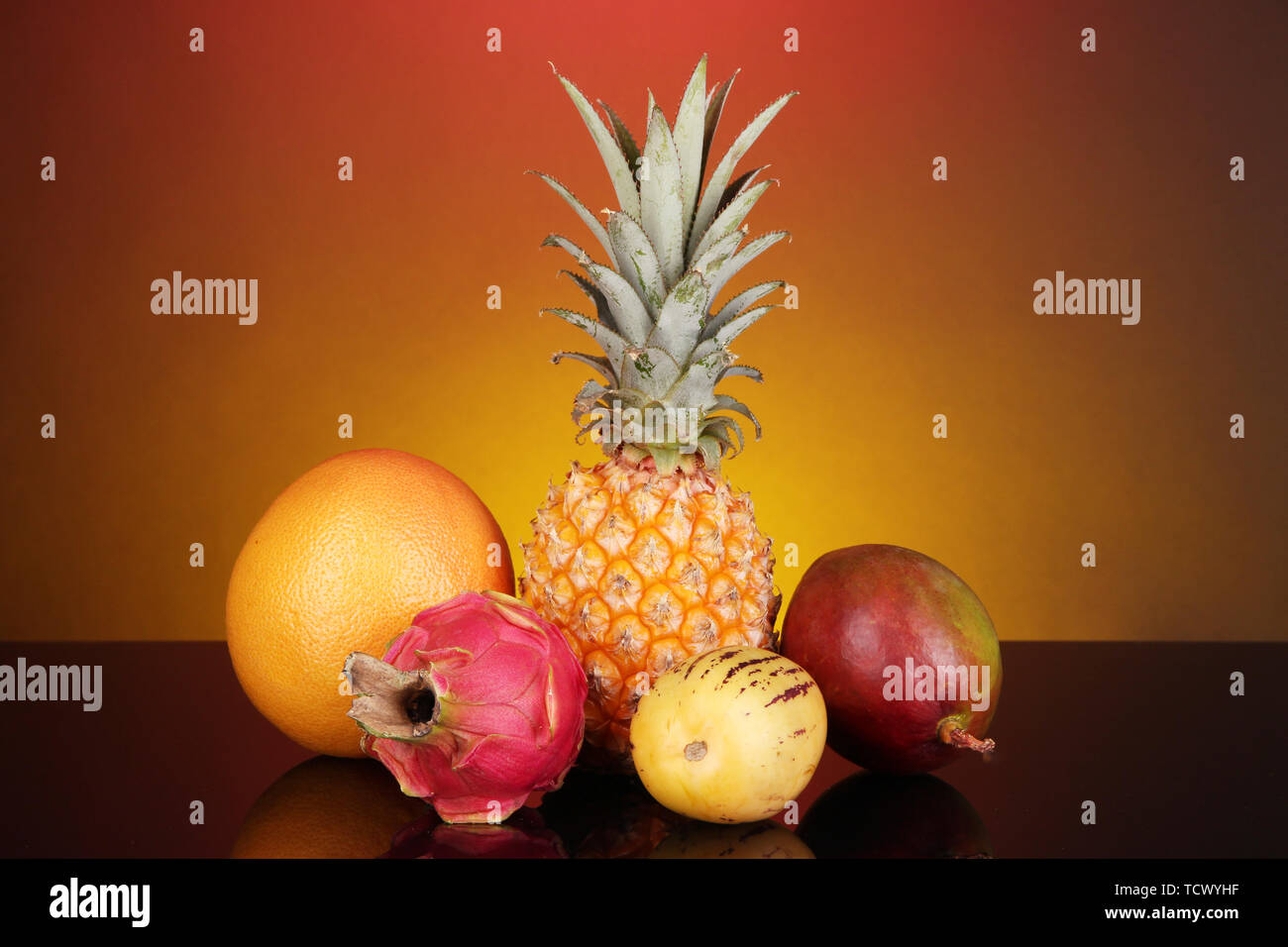 Composition of exotic fruits on colorful background Stock Photo - Alamy
