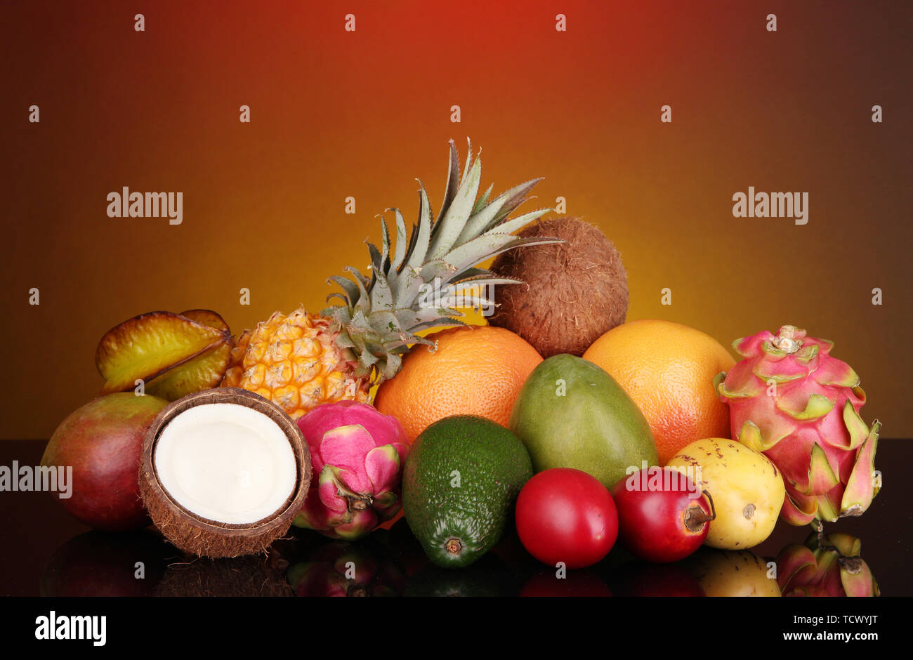 Composition of exotic fruits on colorful background Stock Photo - Alamy