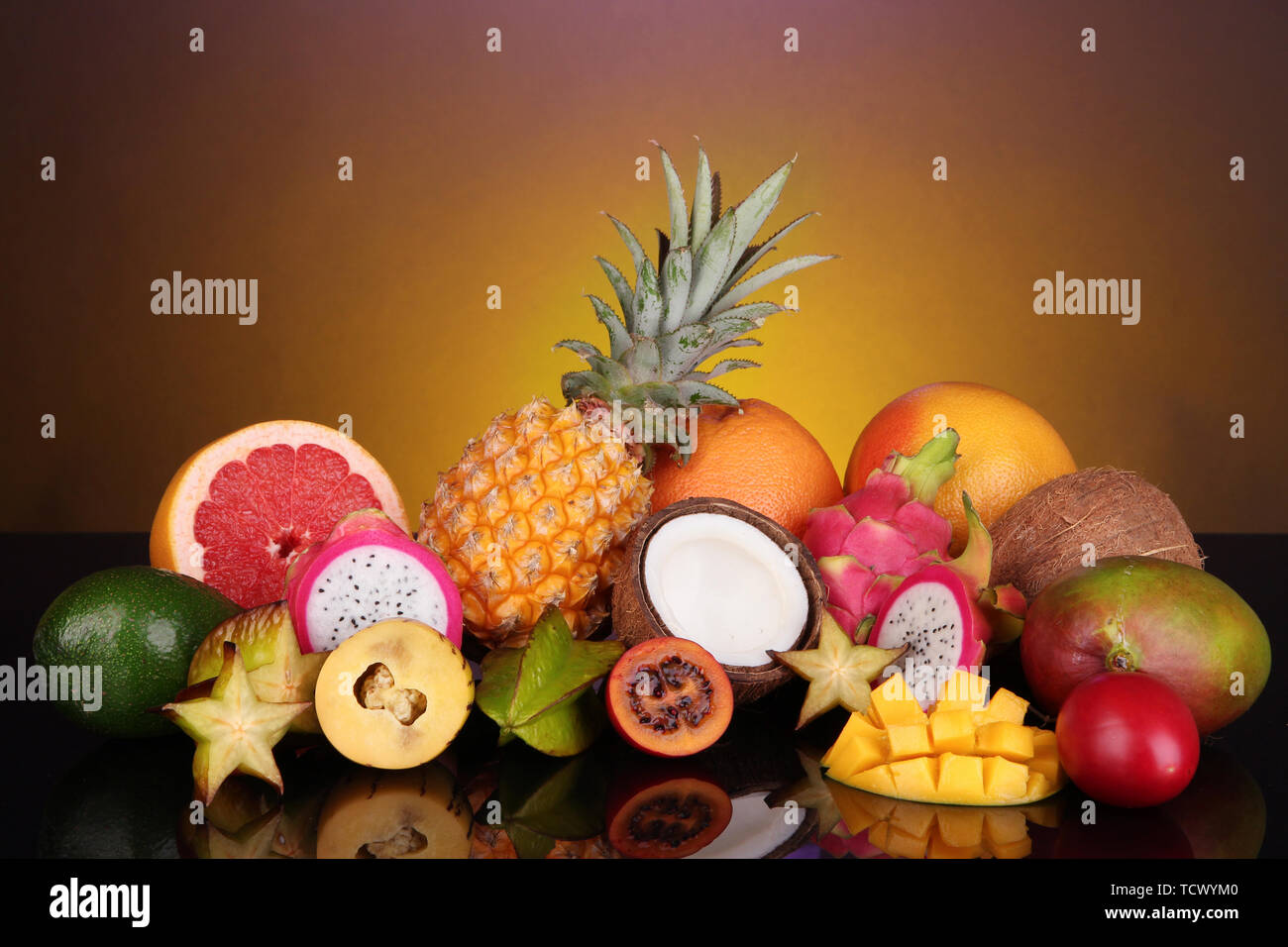 Composition of exotic fruits on colorful background Stock Photo - Alamy