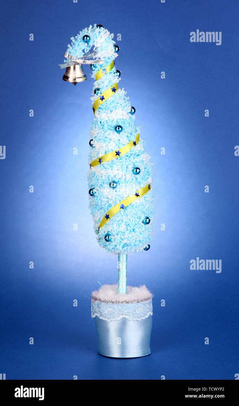 Christmas tree with curved tip on blue background Stock Photo - Alamy