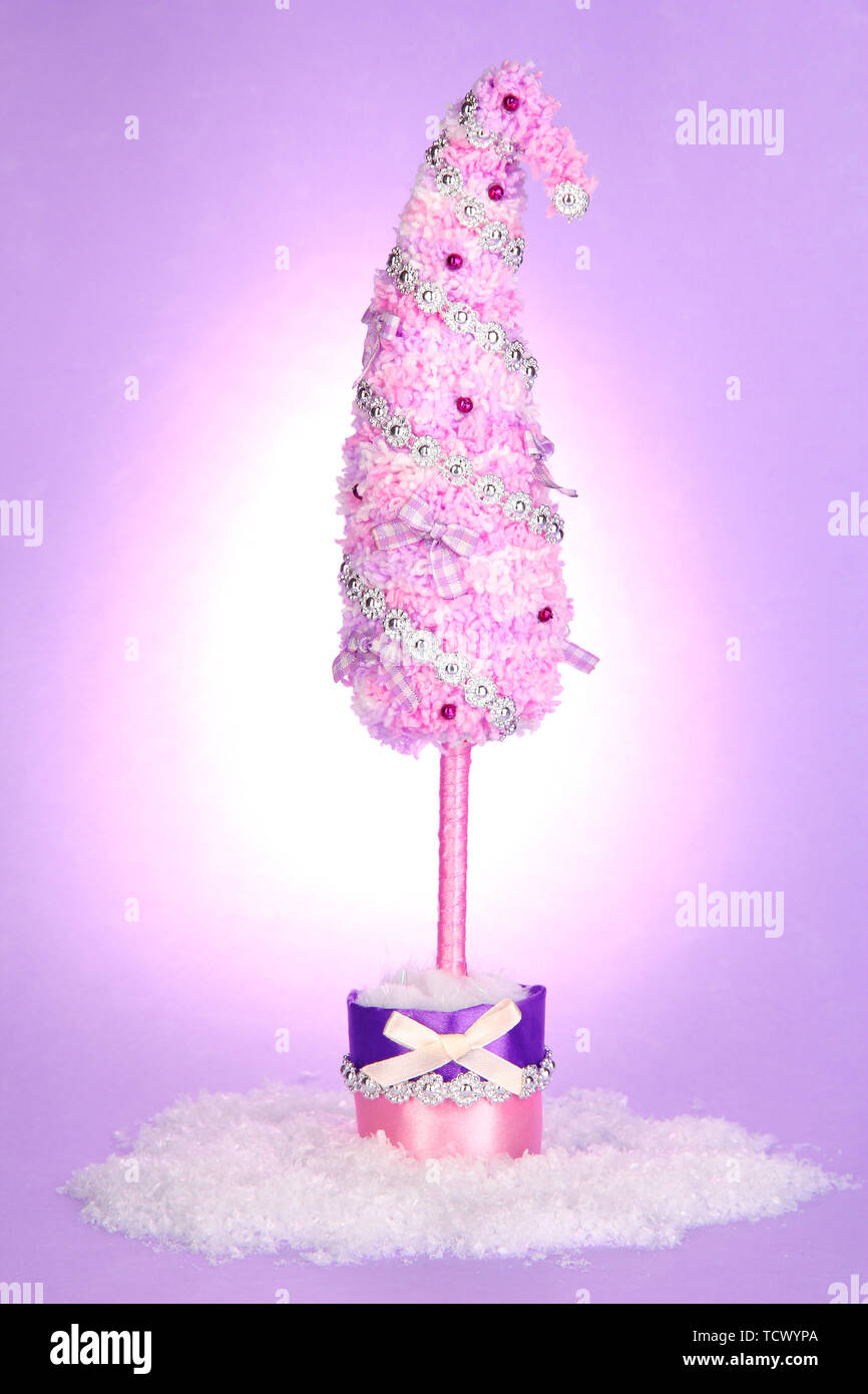 Christmas tree with curved tip on lilac background Stock Photo - Alamy