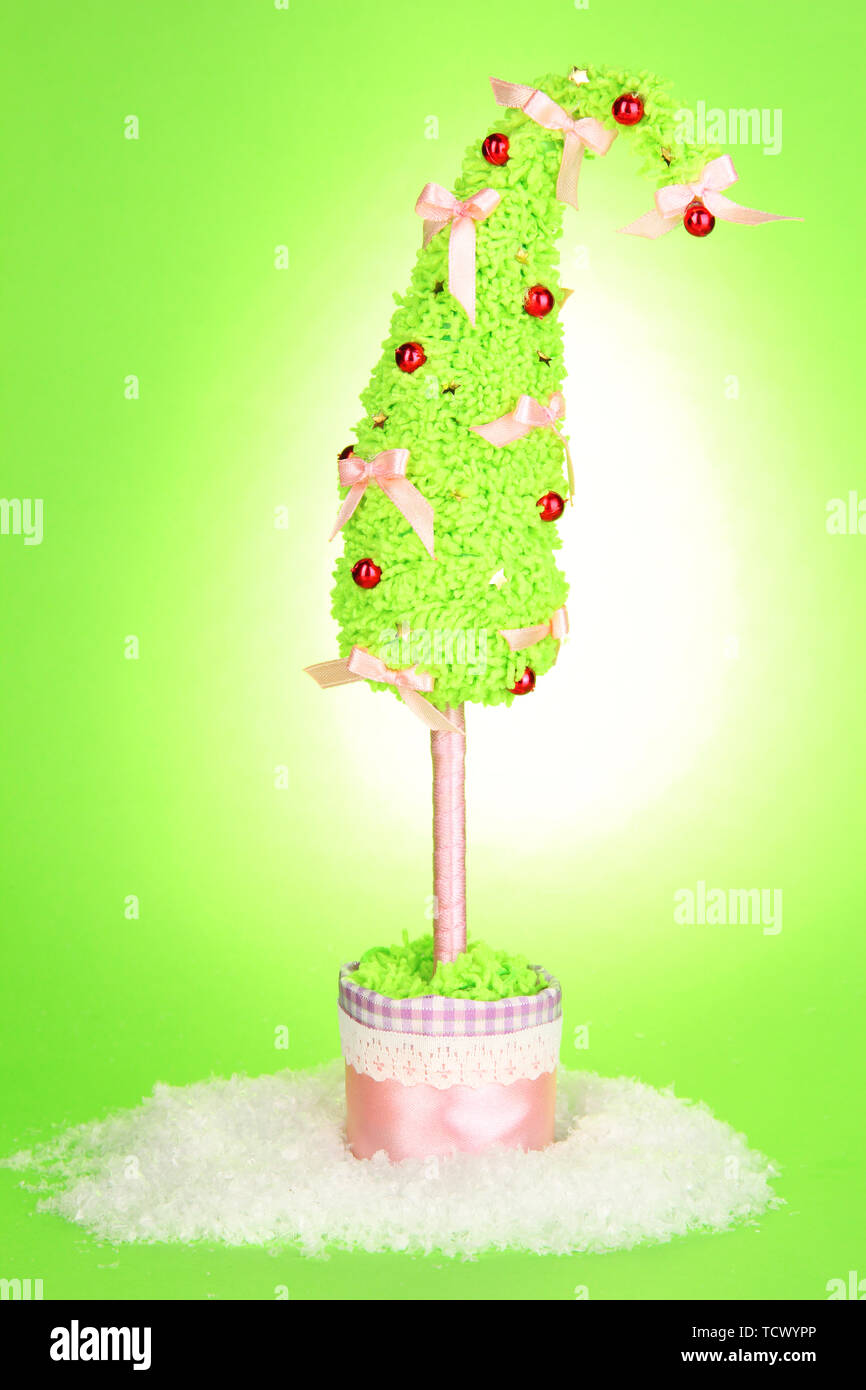 Christmas tree with curved tip on green background Stock Photo - Alamy
