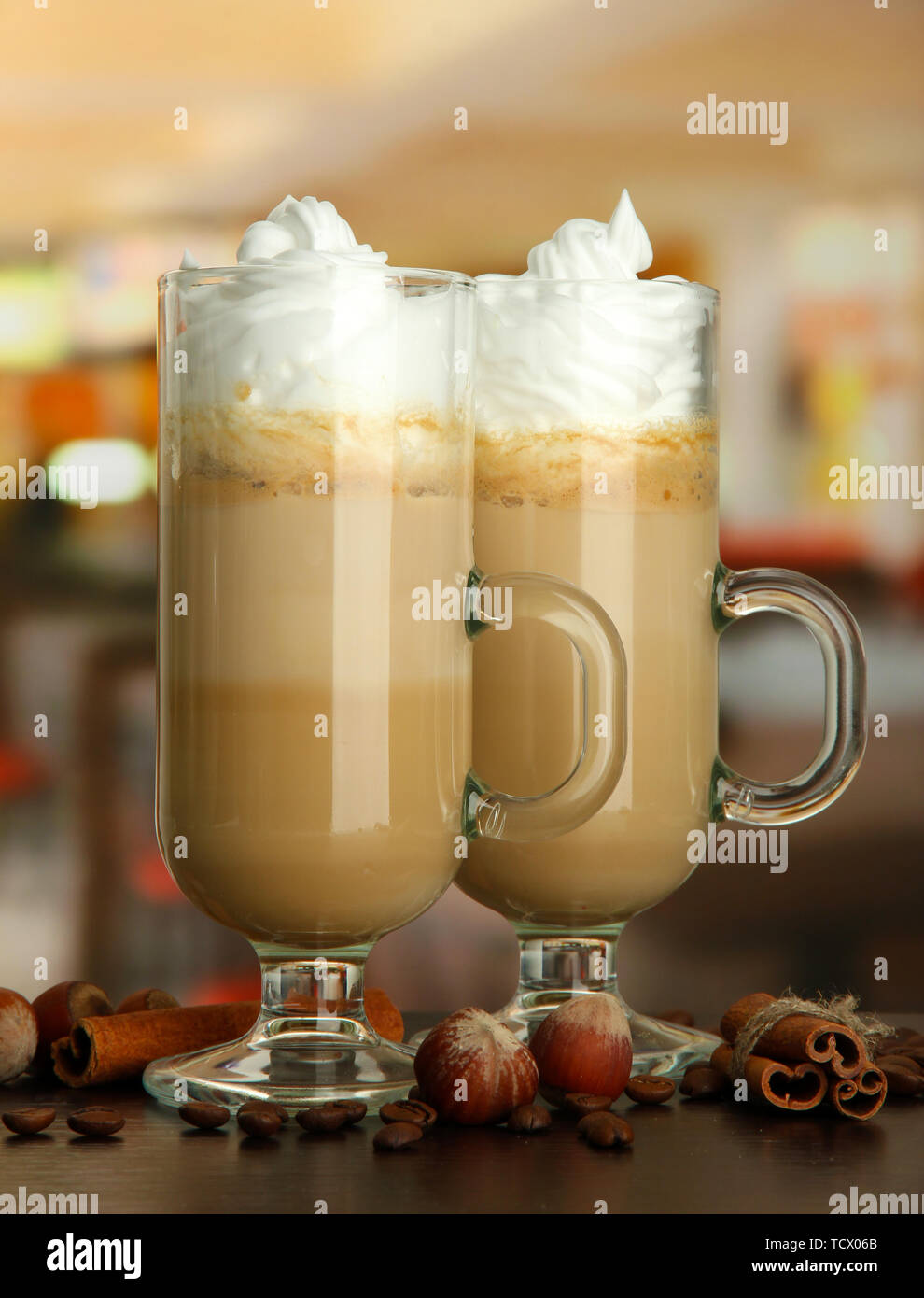 Fragrant coffee latte in glasses cups with spices, on table in cafe ...