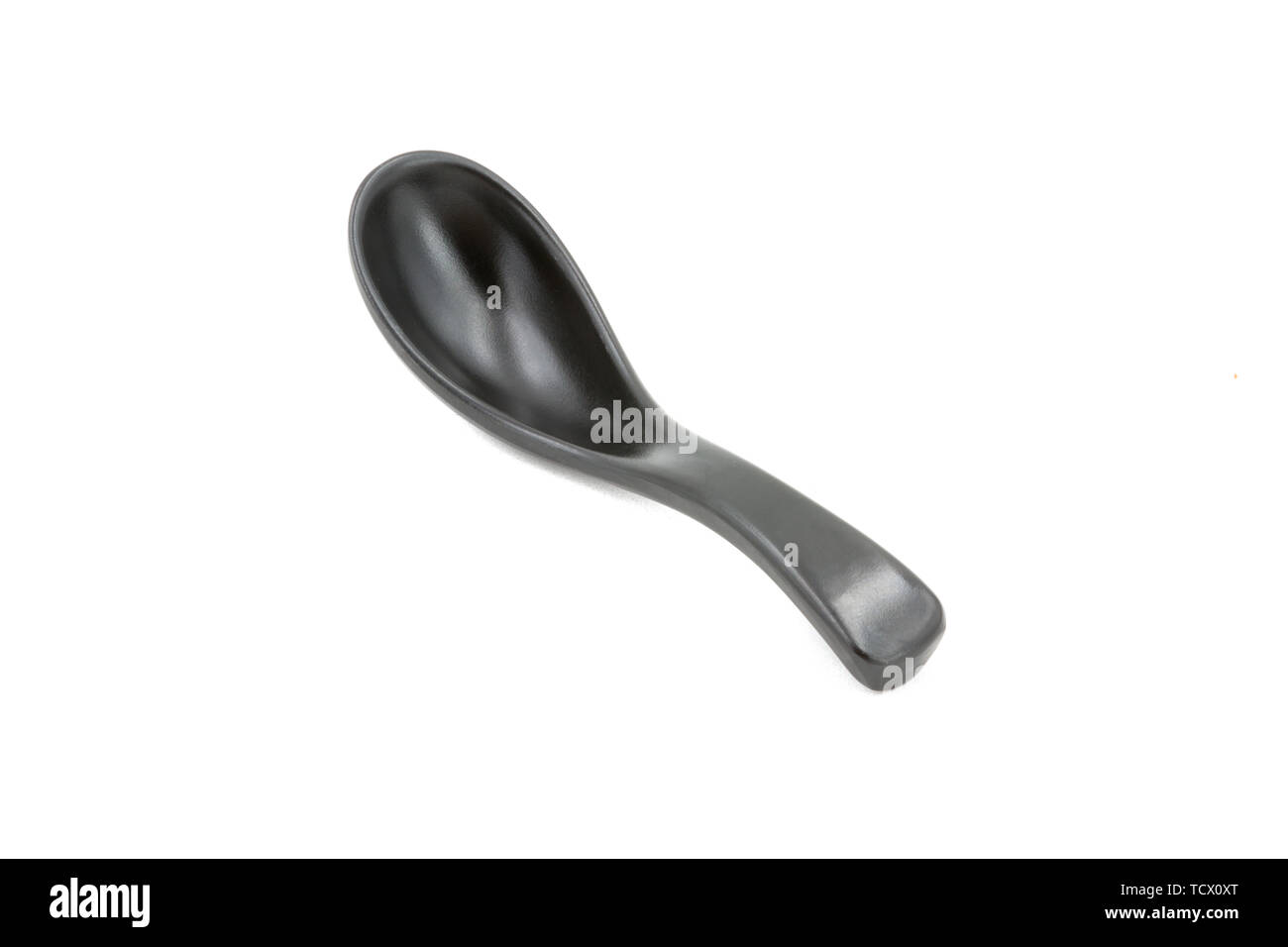 Black spoon on white background Stock Photo - Alamy