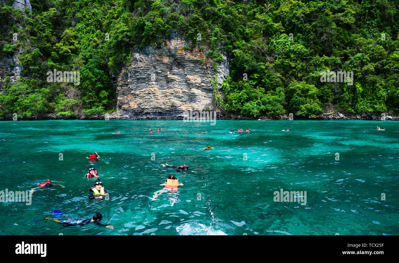 Phuket, Thailand - Jun 20, 2016. Tourist snorkeling in clear and ...