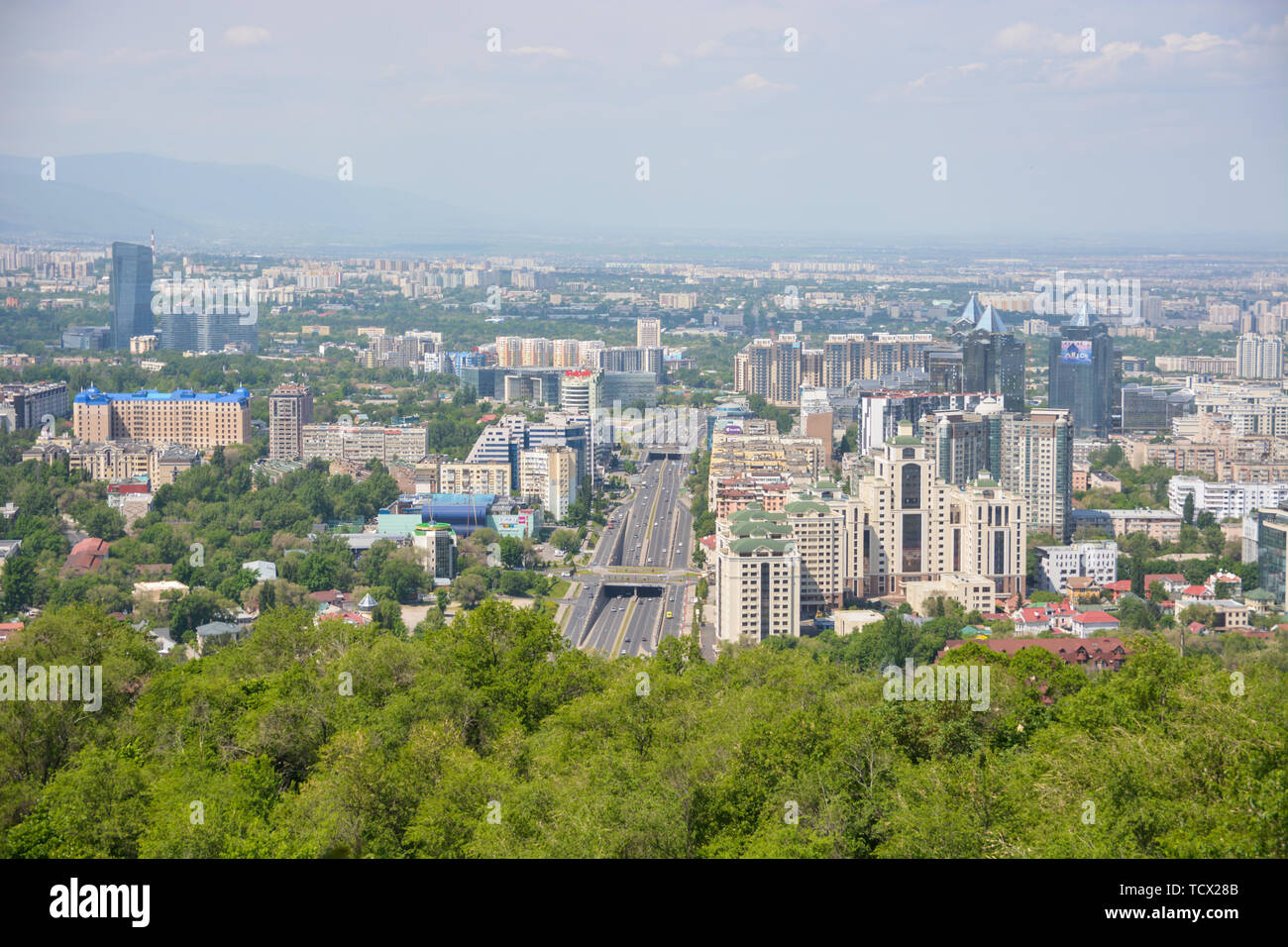 Panoramic view of the city of Almaty, with industrial zone, mountains ...