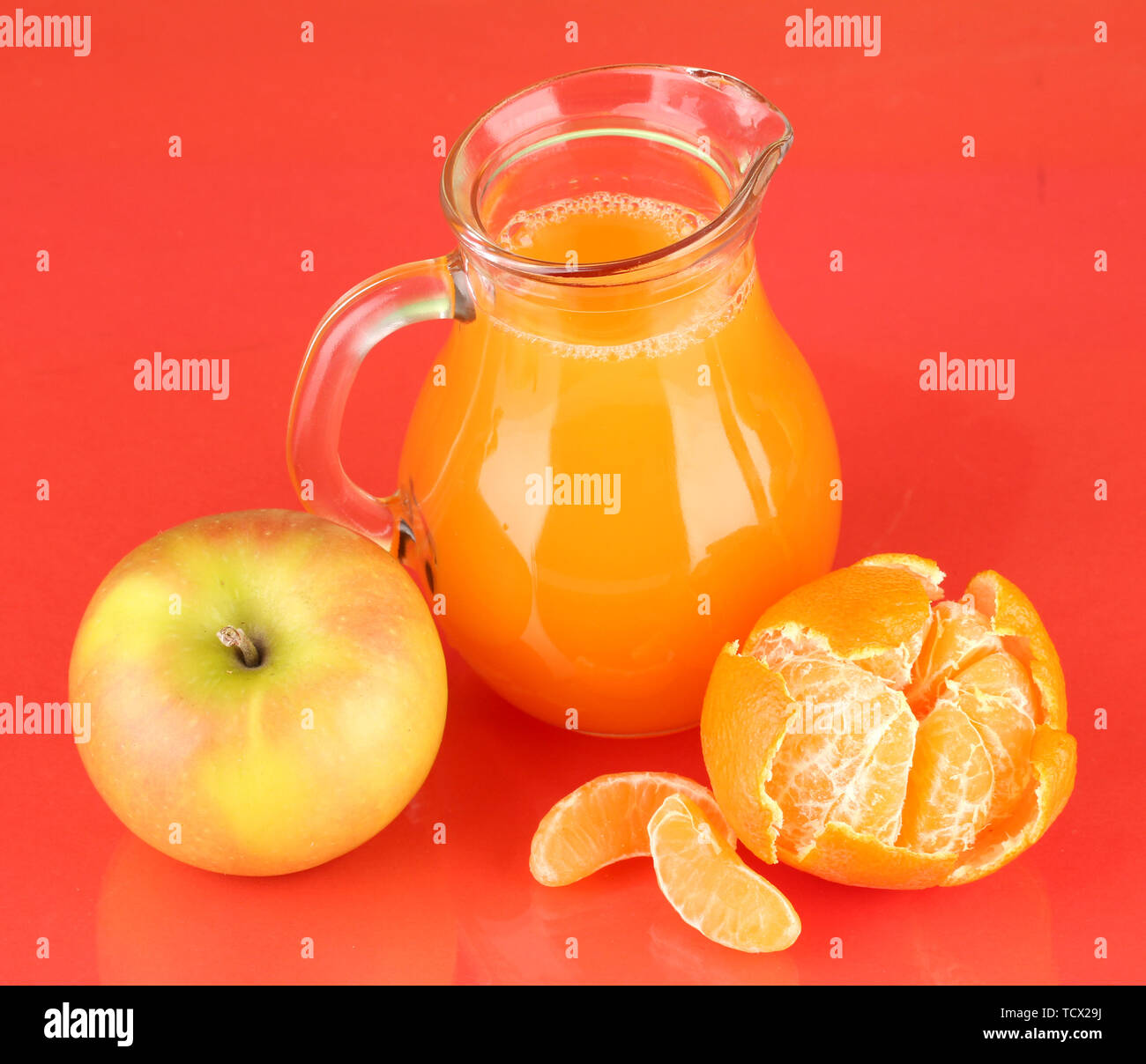 Full jug of multivitamin juice on color background Stock Photo - Alamy