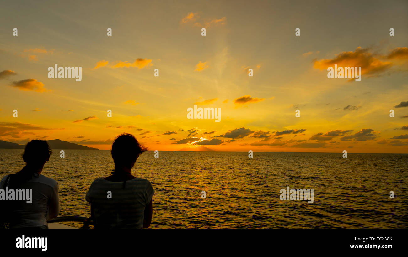 silhouettes of two women watching sunset Stock Photo - Alamy