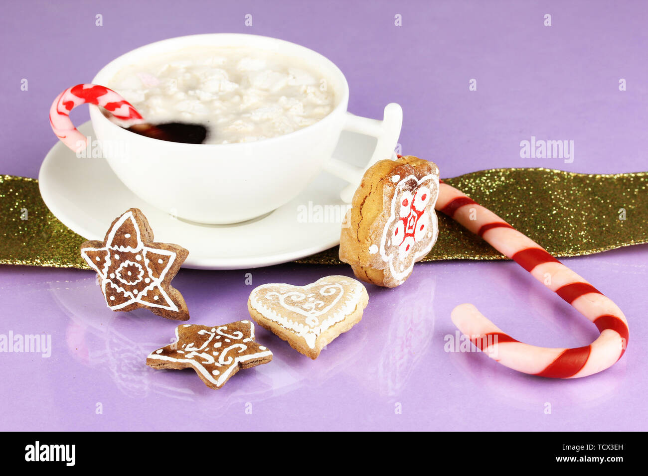Cup of coffee with Christmas sweetness on purple background Stock Photo ...
