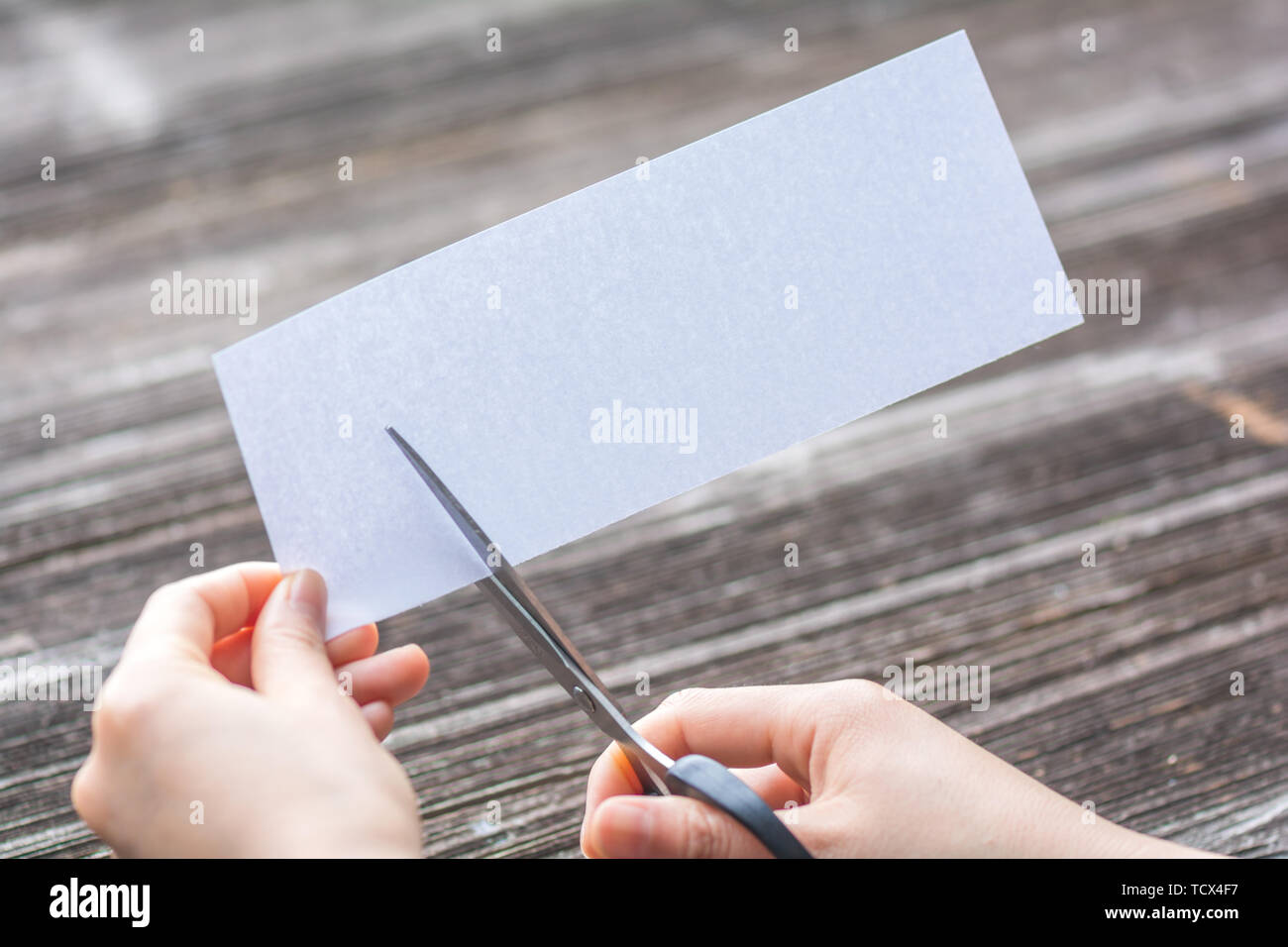 woman cutting paper by scissors Stock Photo - Alamy