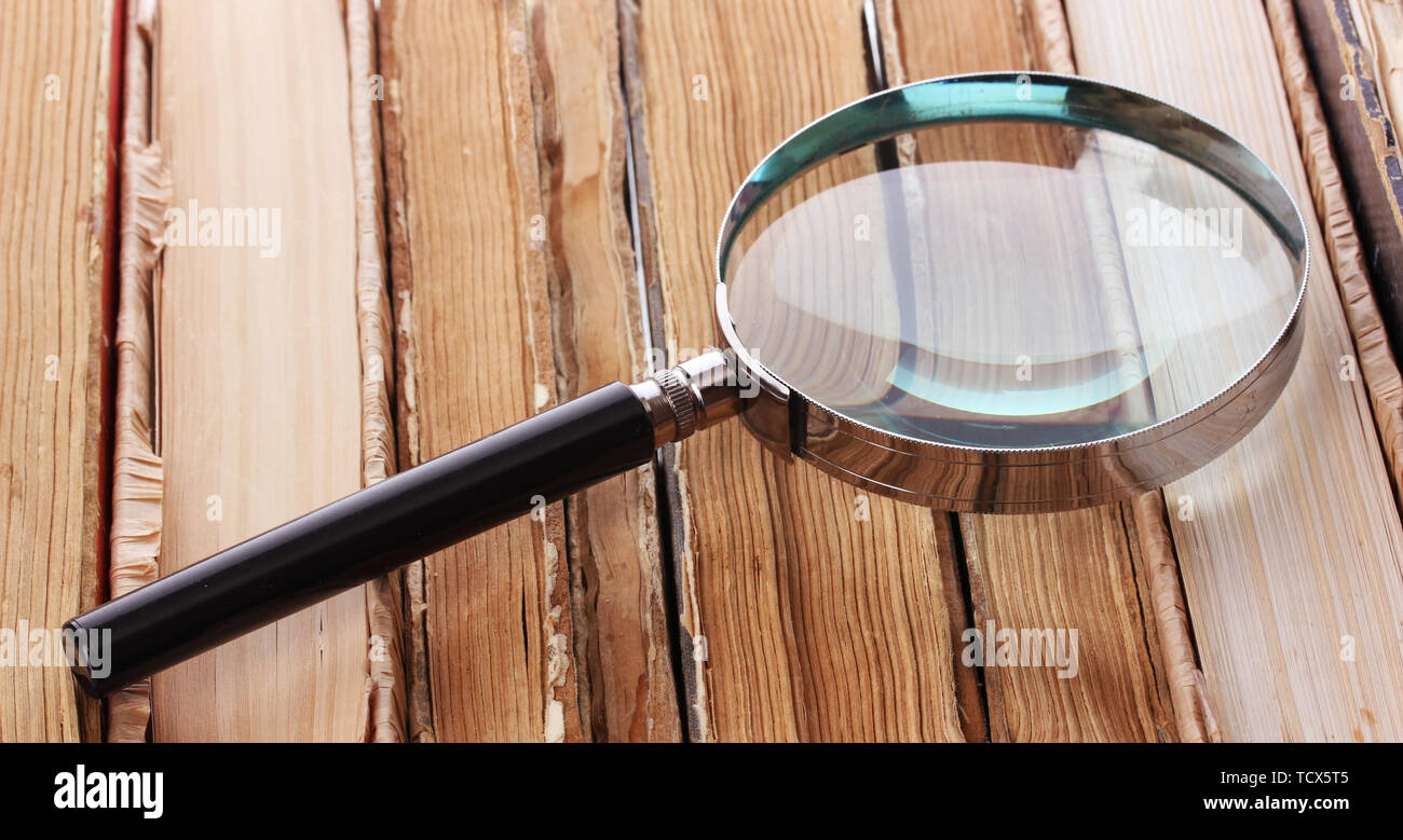 Magnifying glass over stack hi-res stock photography and images - Alamy