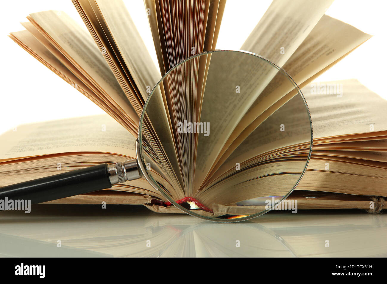 Magnifying glass and open book isolated on white Stock Photo - Alamy