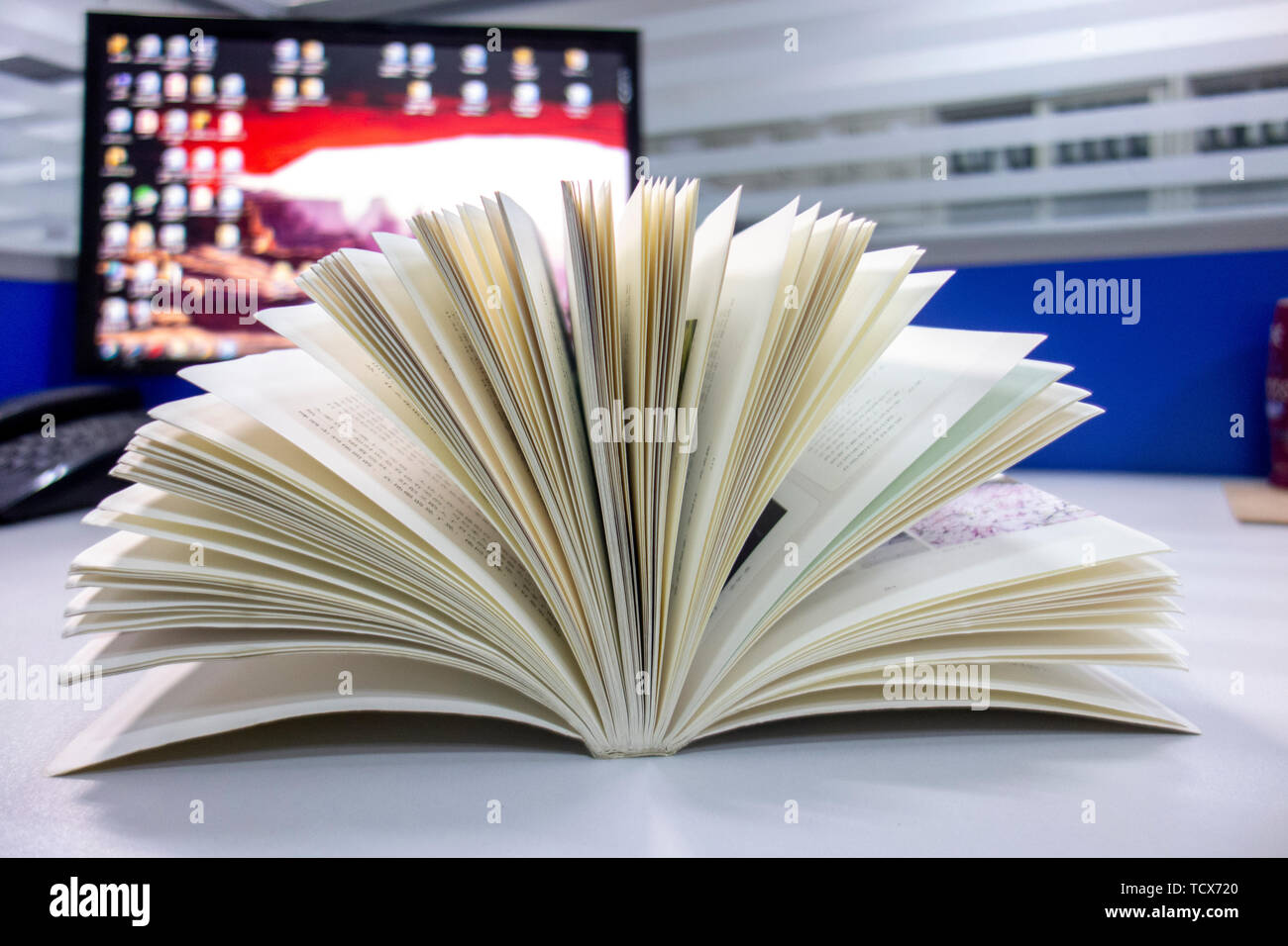 Open book on desk Stock Photo - Alamy
