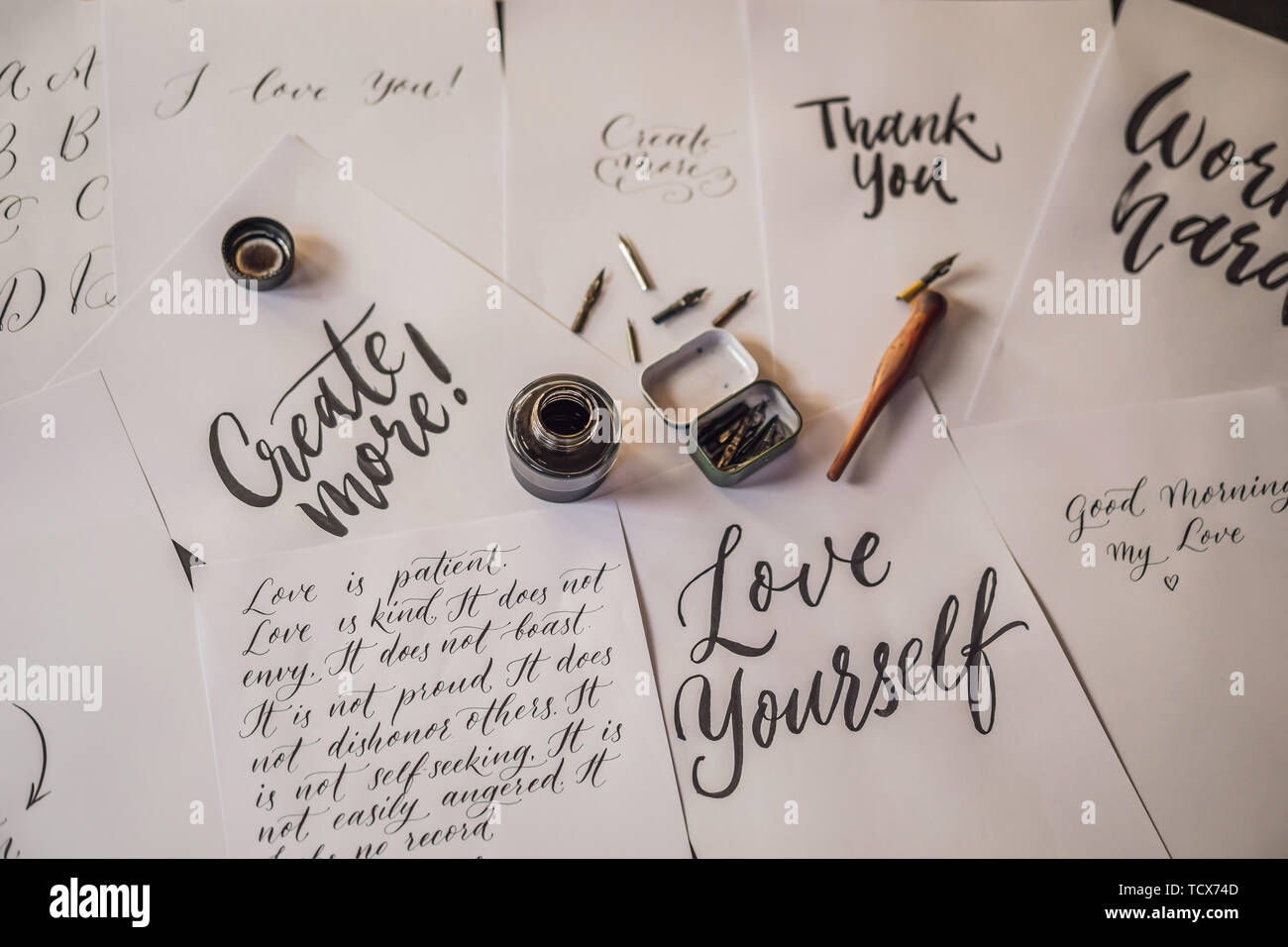 Lettering, calligraphy, writes phrase on white paper. Inscribing ...