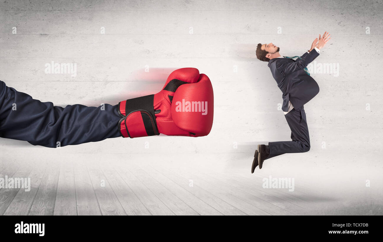 Arm with red boxing gloves hits office worker concept Stock Photo - Alamy